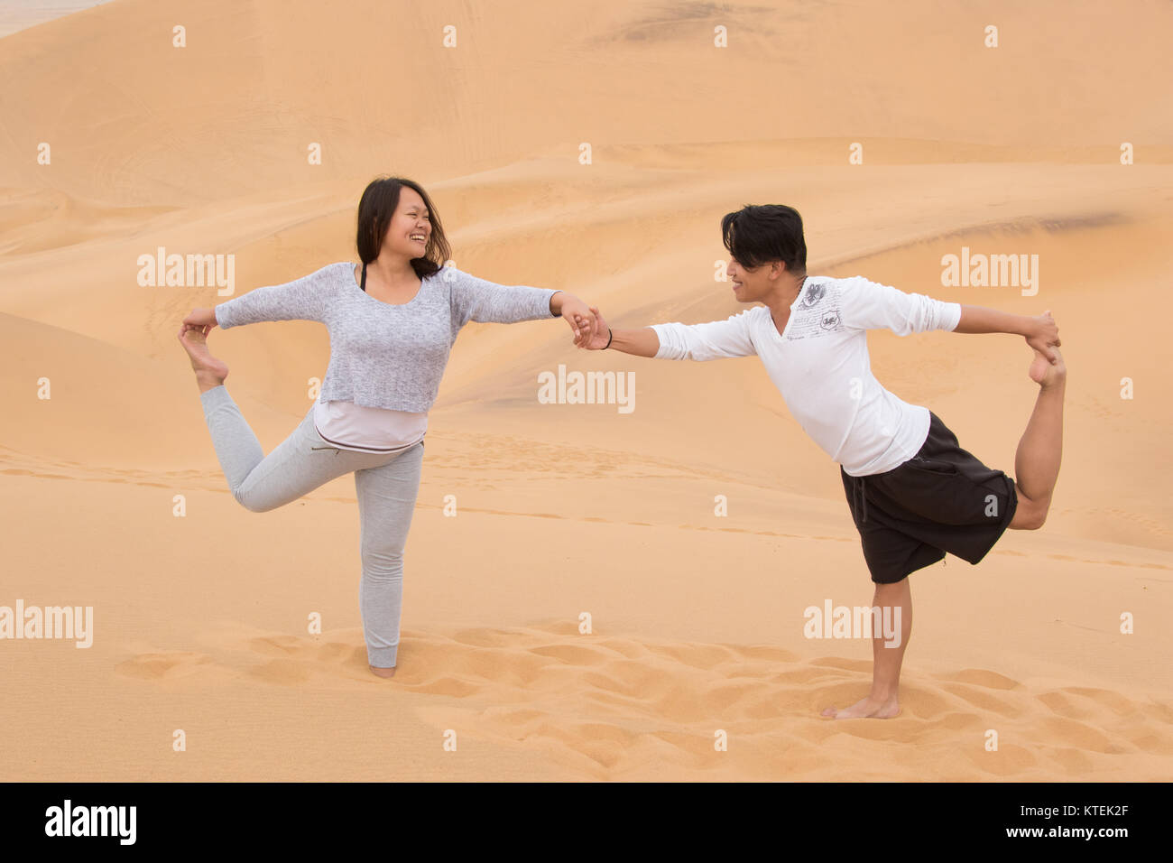 An Indonesian girl and Filipino boy doing yoga exercises on Dune 7, the ...
