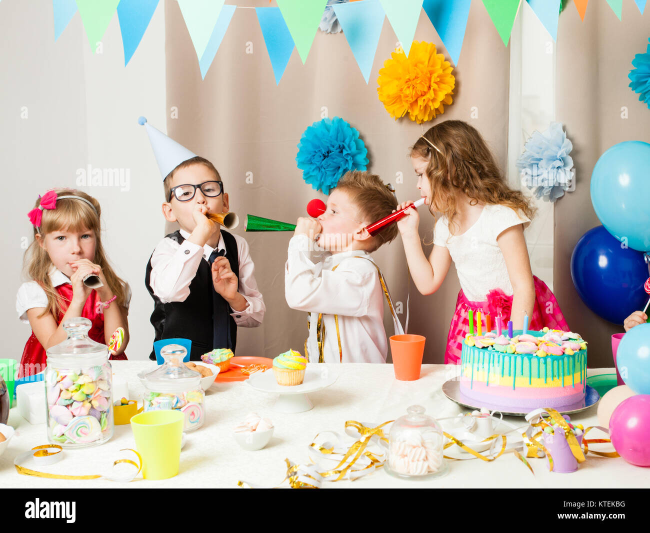 Group of smiling children playing on the birthday party in decorated ...