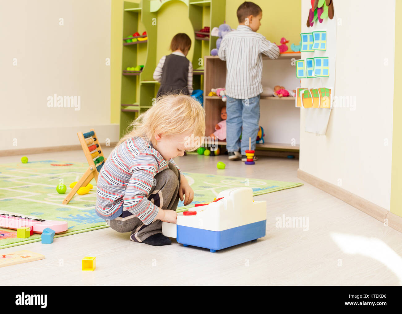 Boy is playing in the role of cashier in the kindergarten Stock Photo ...