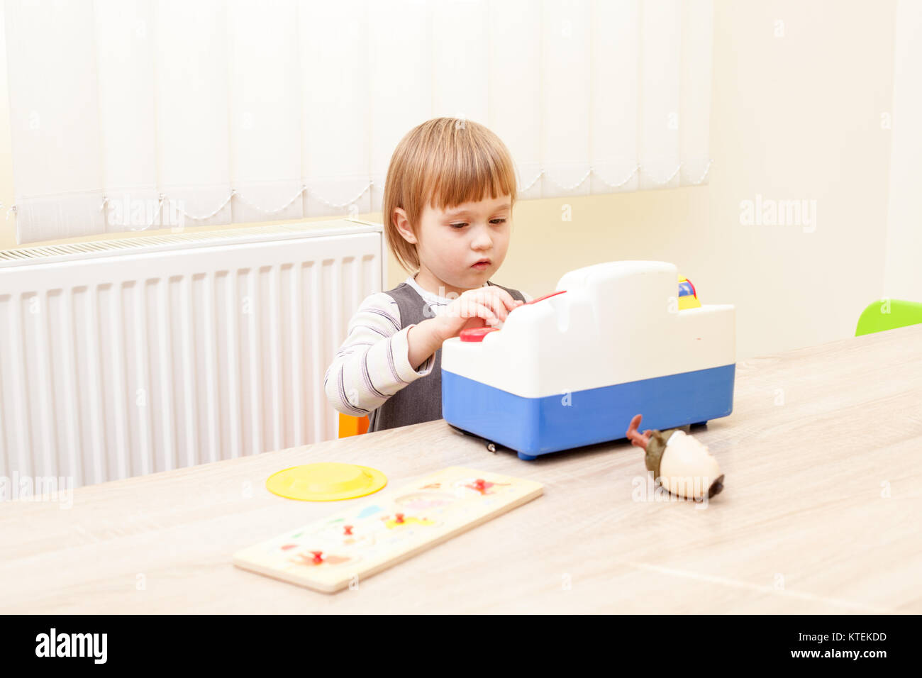 Girl is playing in the role of cashier in the kindergarten Stock Photo ...