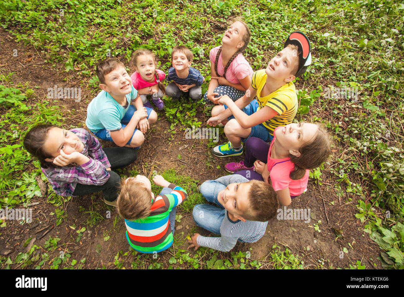 Group of children who are considering something carefully, sitting in a ...