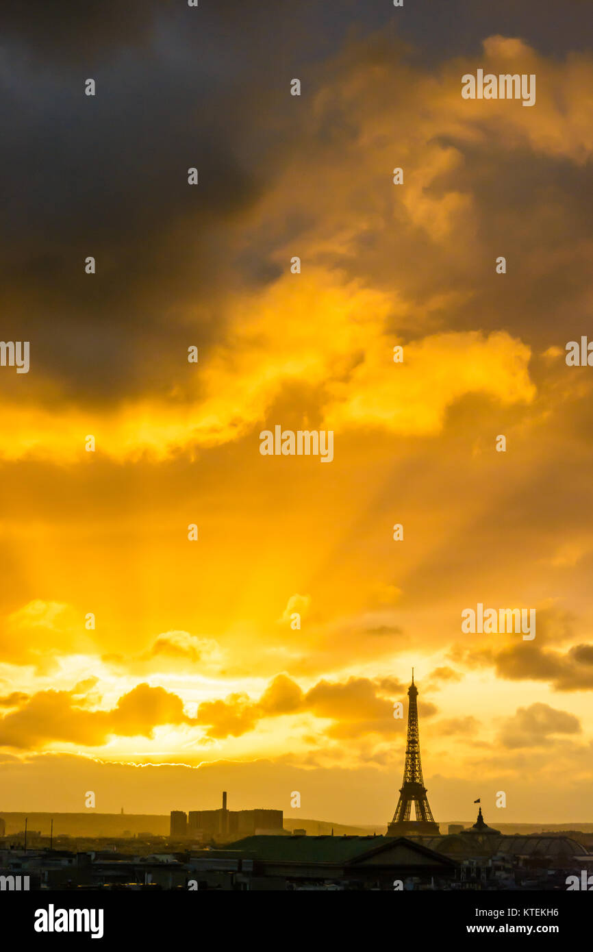 Cityscape of a blazing sunset over Paris skyline with the silhouette of ...