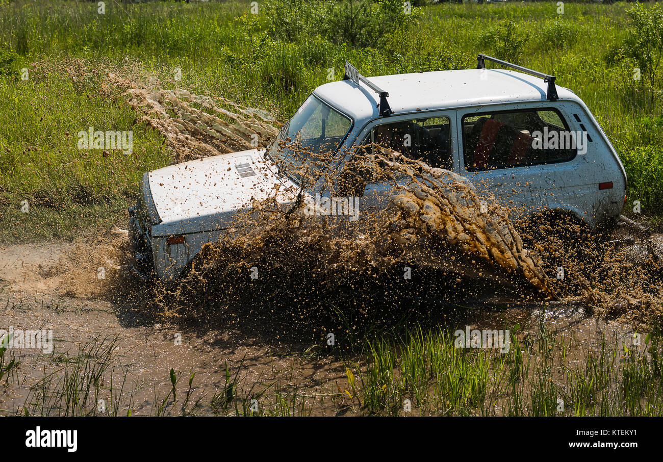 Lviv, Ukraine - May 30, 2015: Off-road vehicle NIVA overcomes the track ...