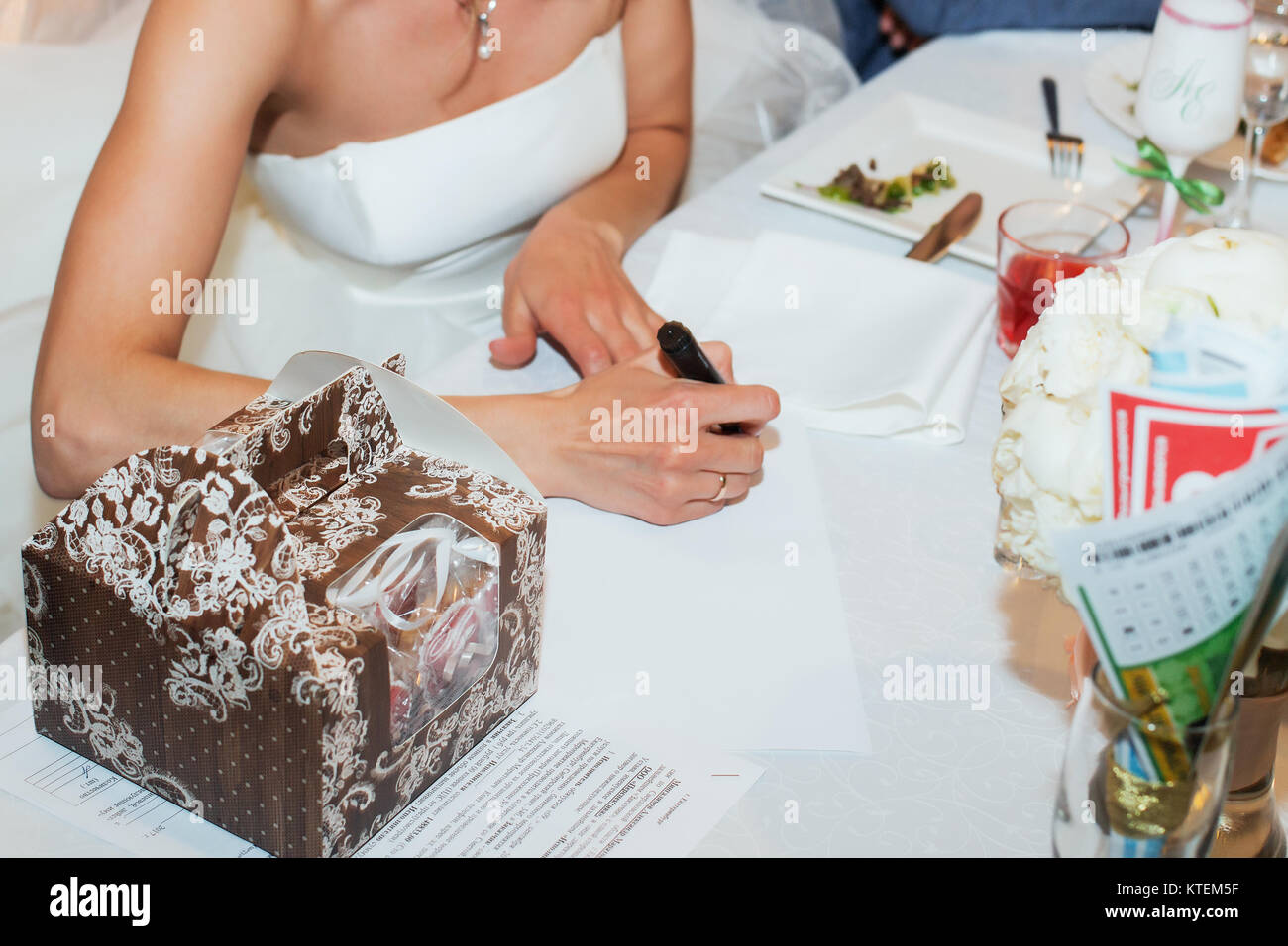 Bride signing marriage certificate hi-res stock photography and images ...