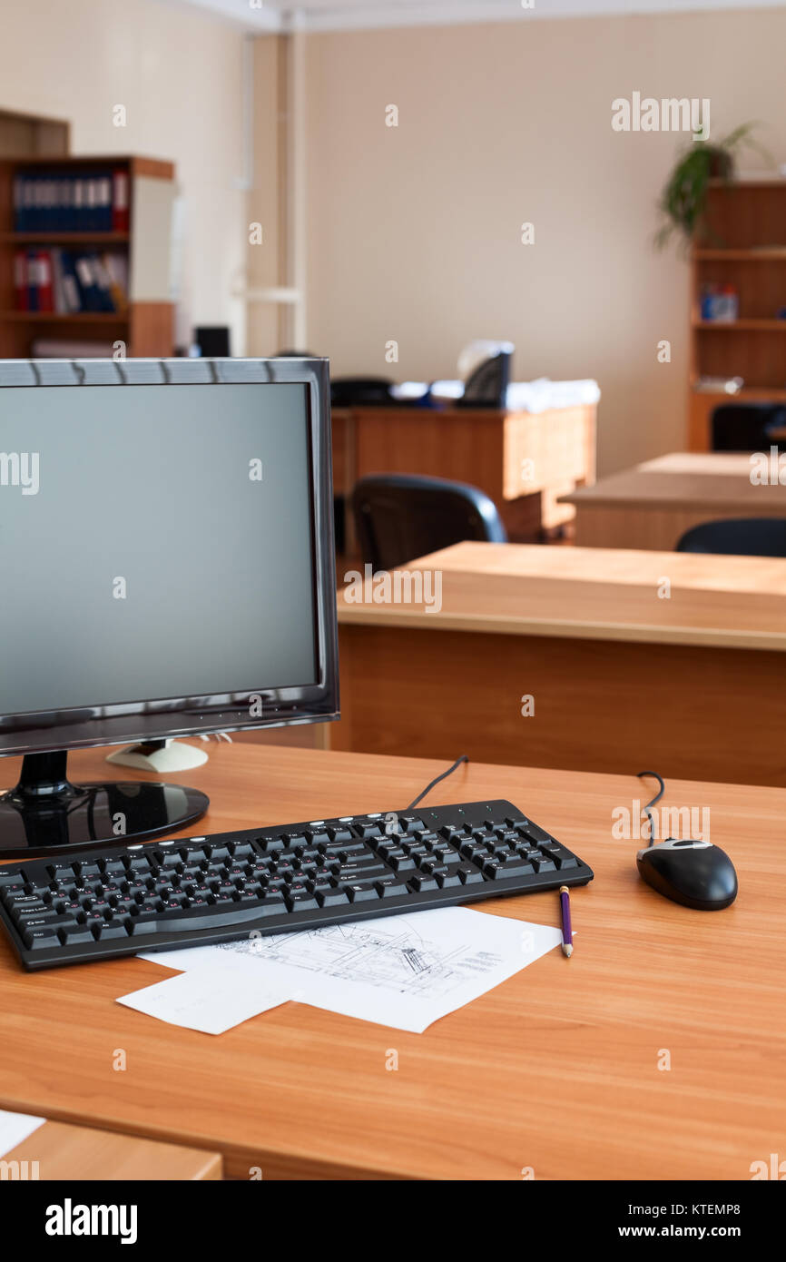 Off unit of computer equipment is in clear work place of empty office ...