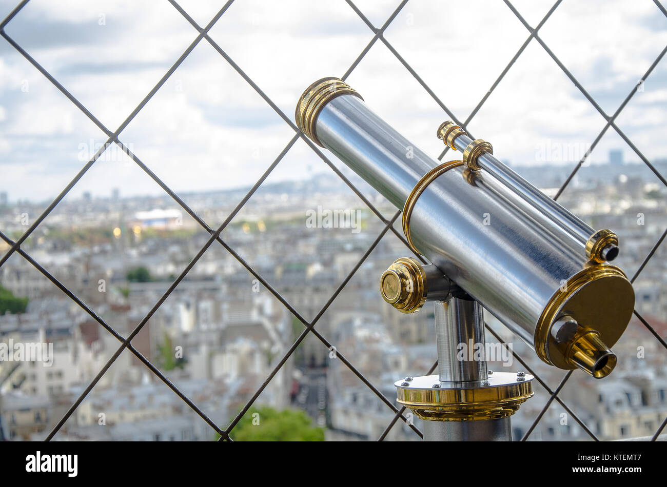 Golden telescope for observing monuments in Paris Stock Photo - Alamy