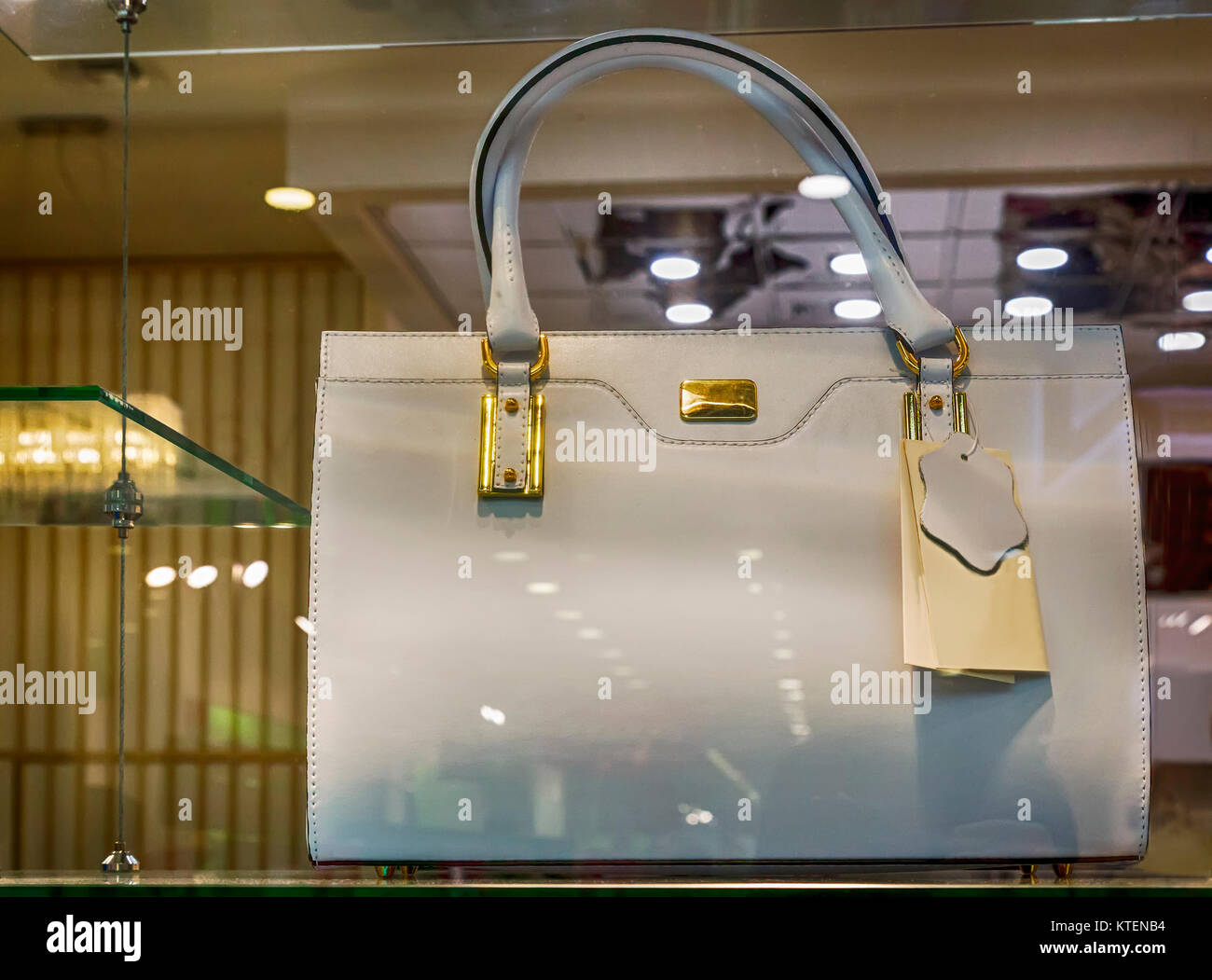 The storefront presents for sale a beautiful white leather womens bag ...