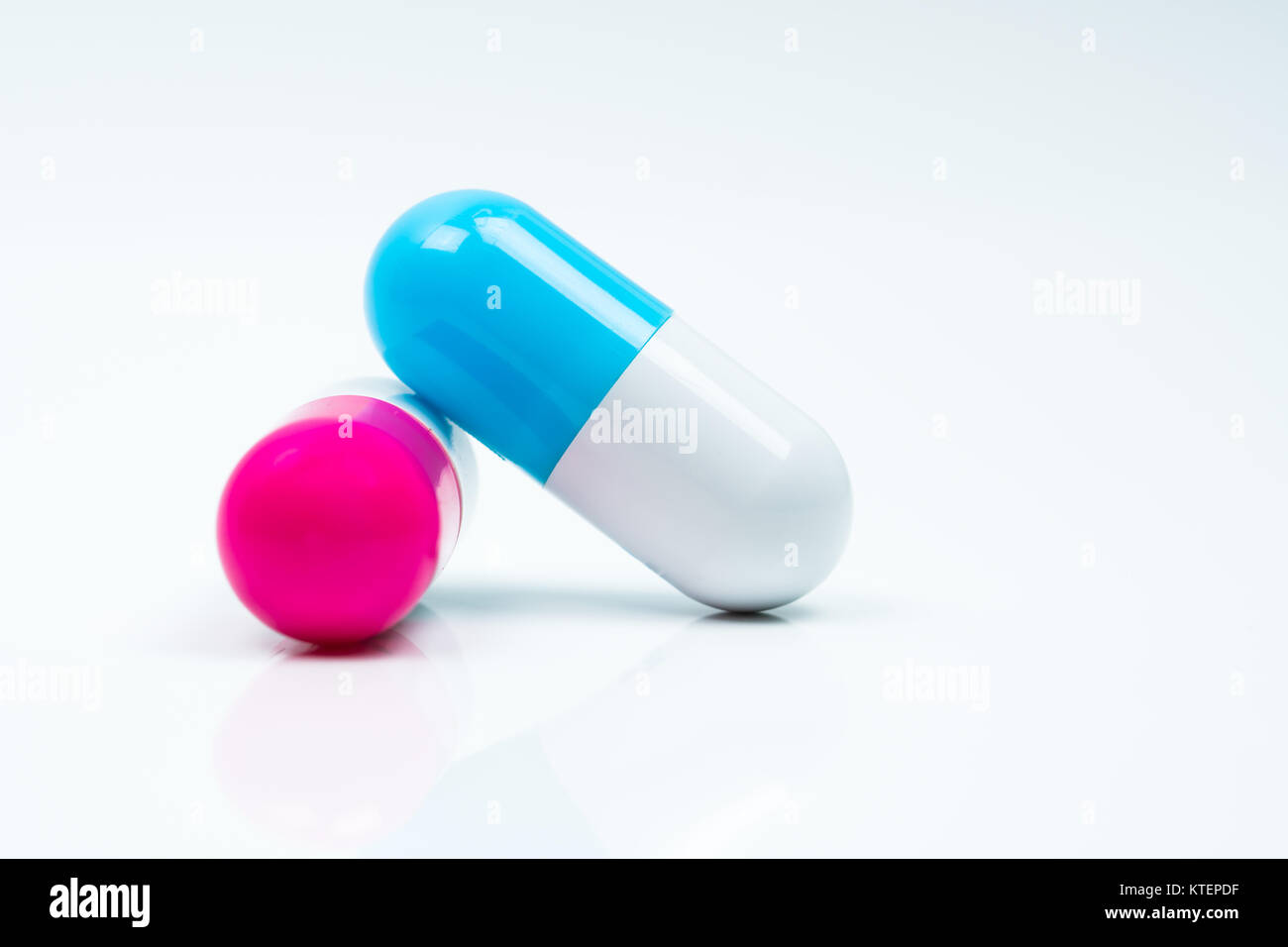 Two capsule pills isolated on white background. Global healthcare ...