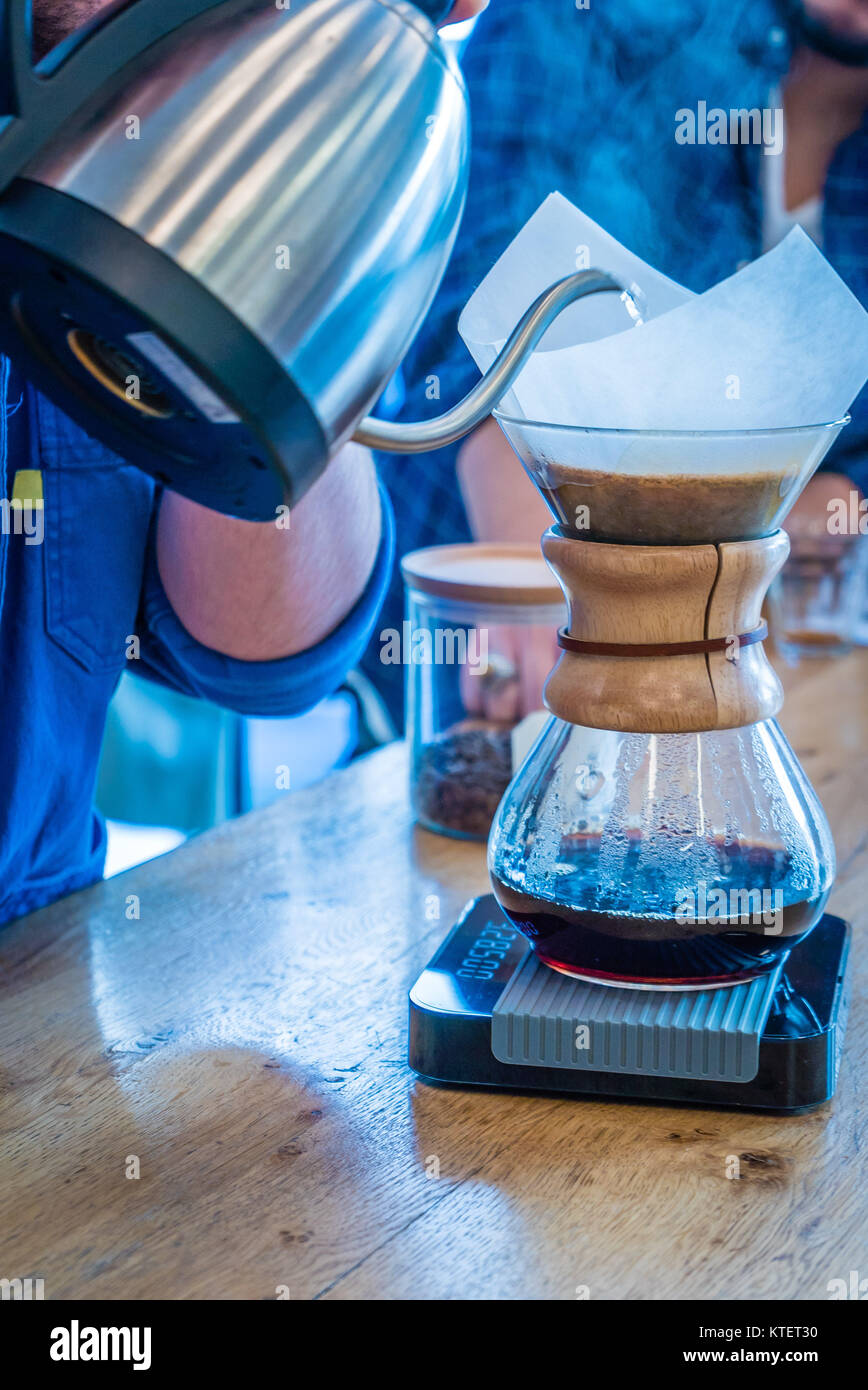 Traditional way of pouring hot water onto coffee Stock Photo - Alamy