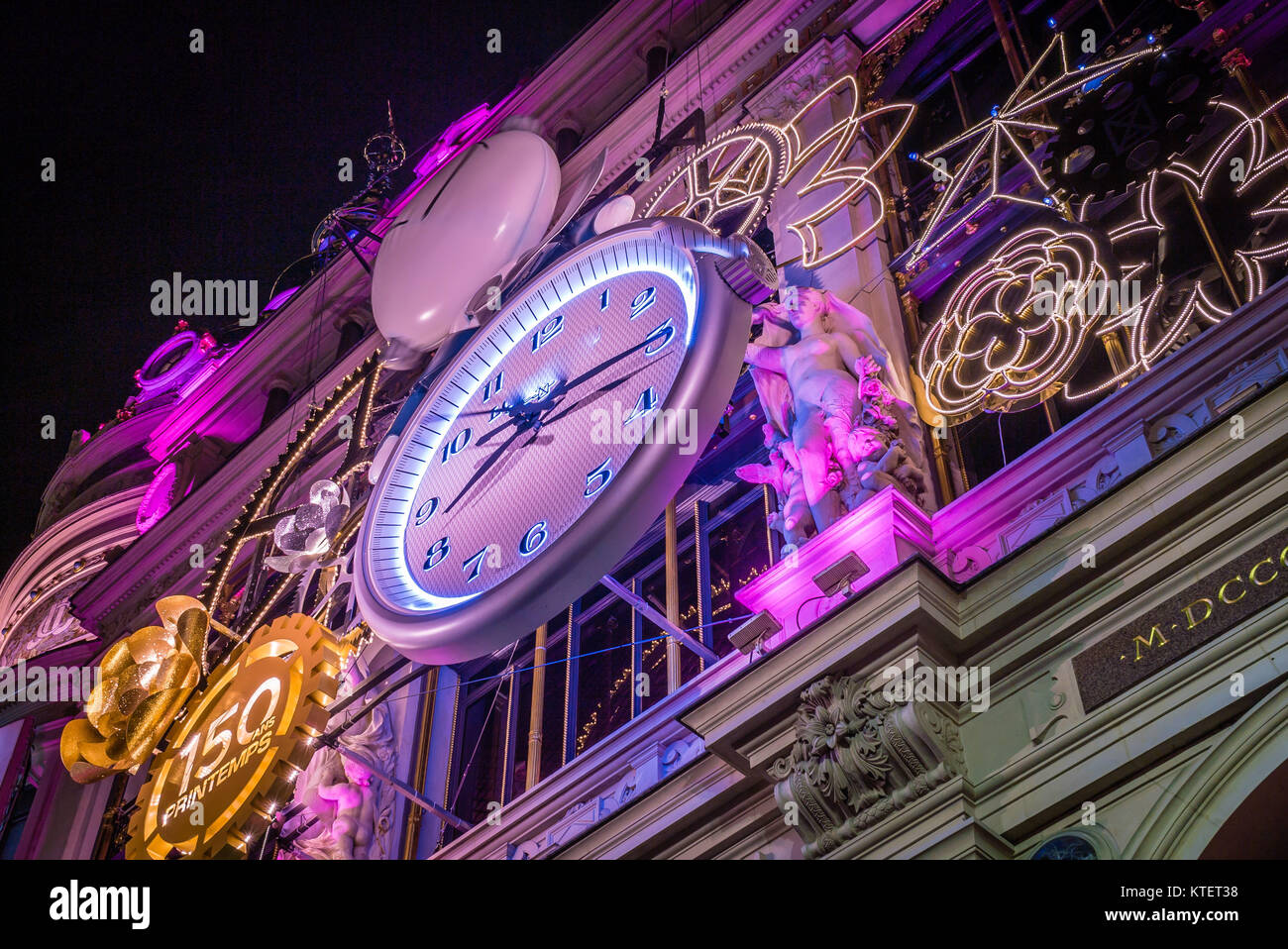 Purple clock of the Printemps galleries in Paris at Christmas Stock ...