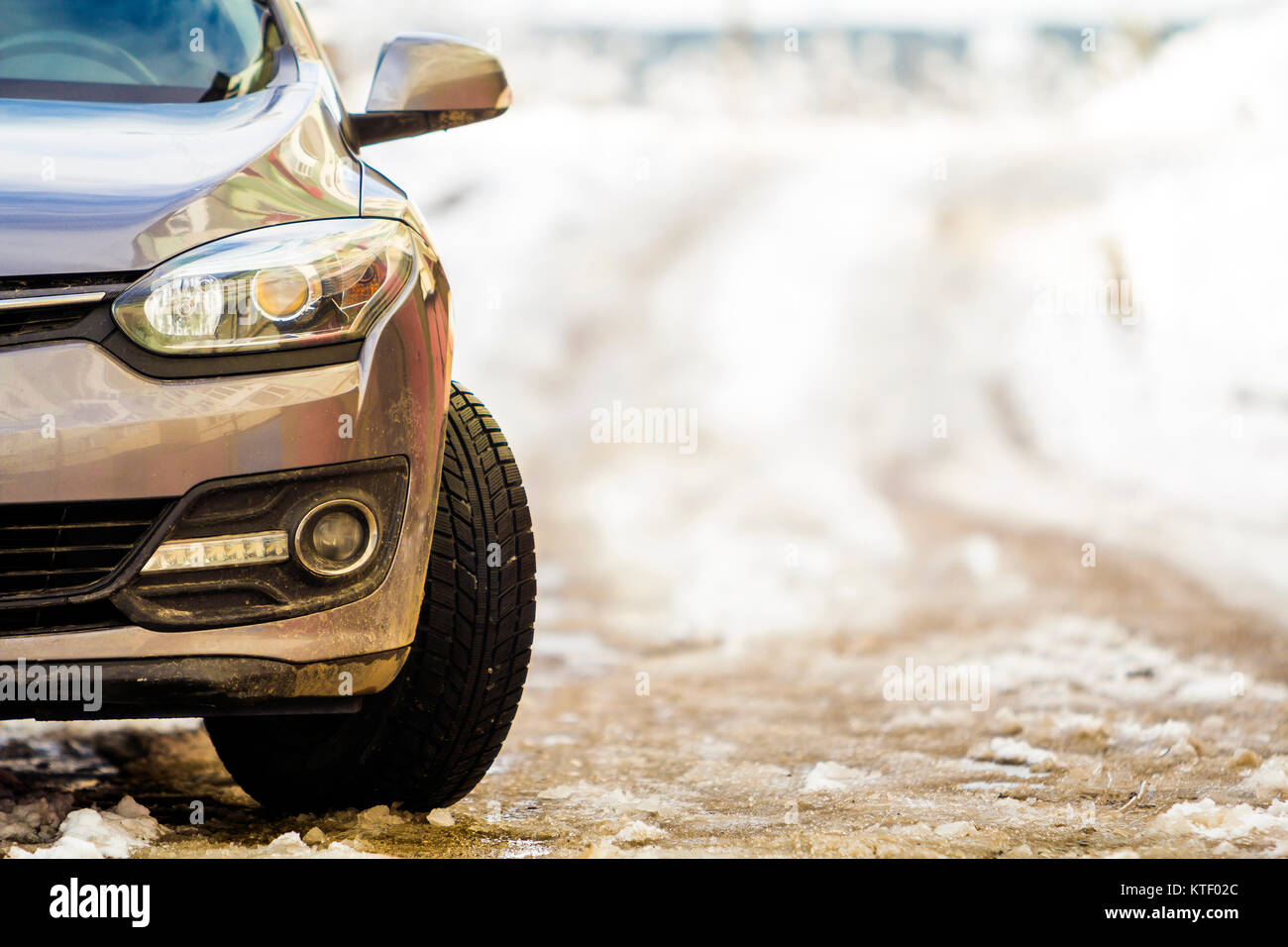 New modern grey car parked on a street in winter Stock Photo - Alamy