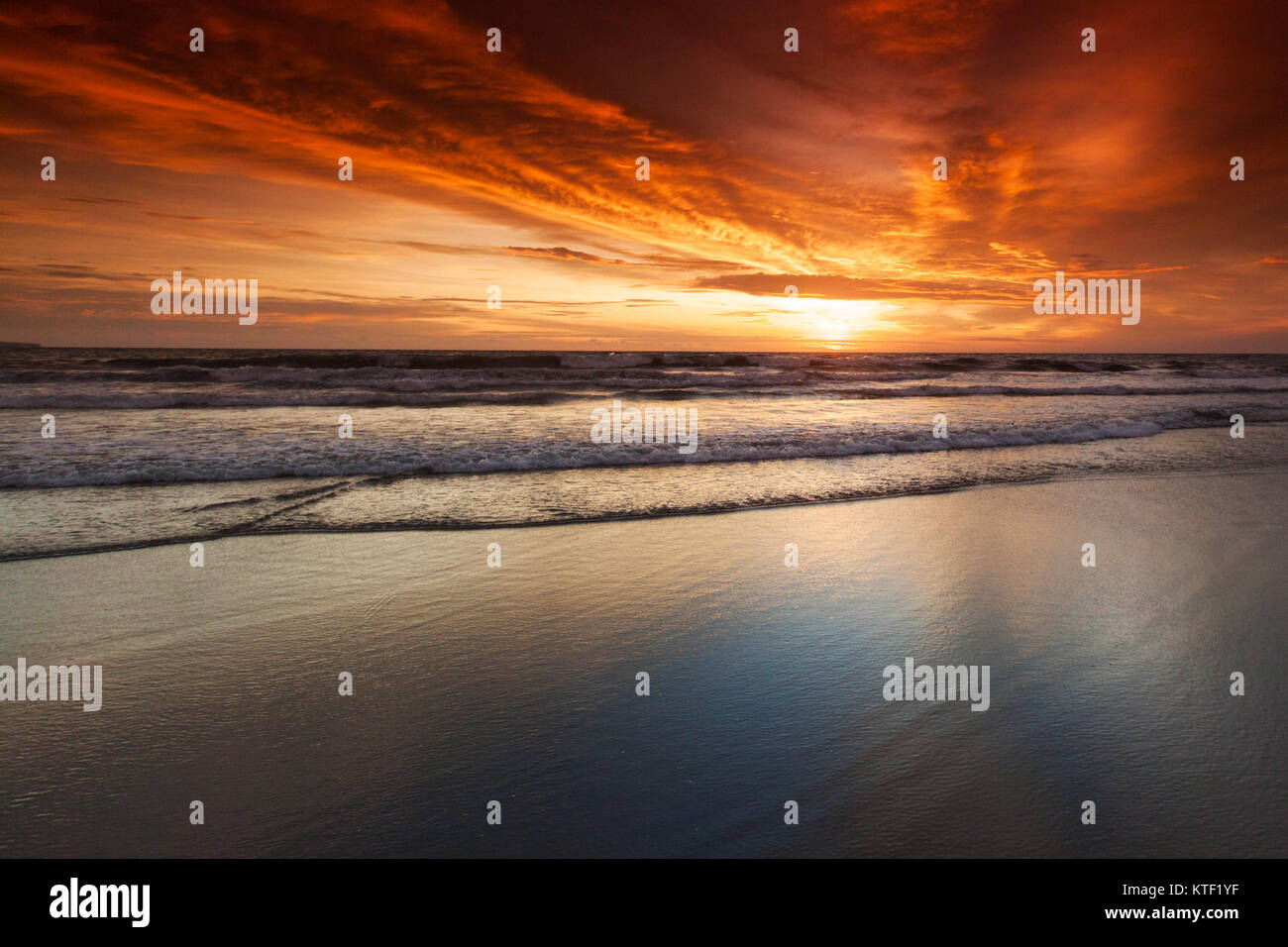 Splashing ocean wave in front of beautiful sunset sky background Stock ...