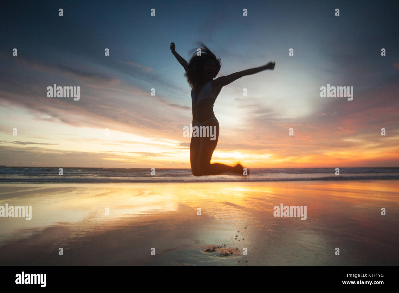 Jumping happy bikini hi-res stock photography and images - Alamy