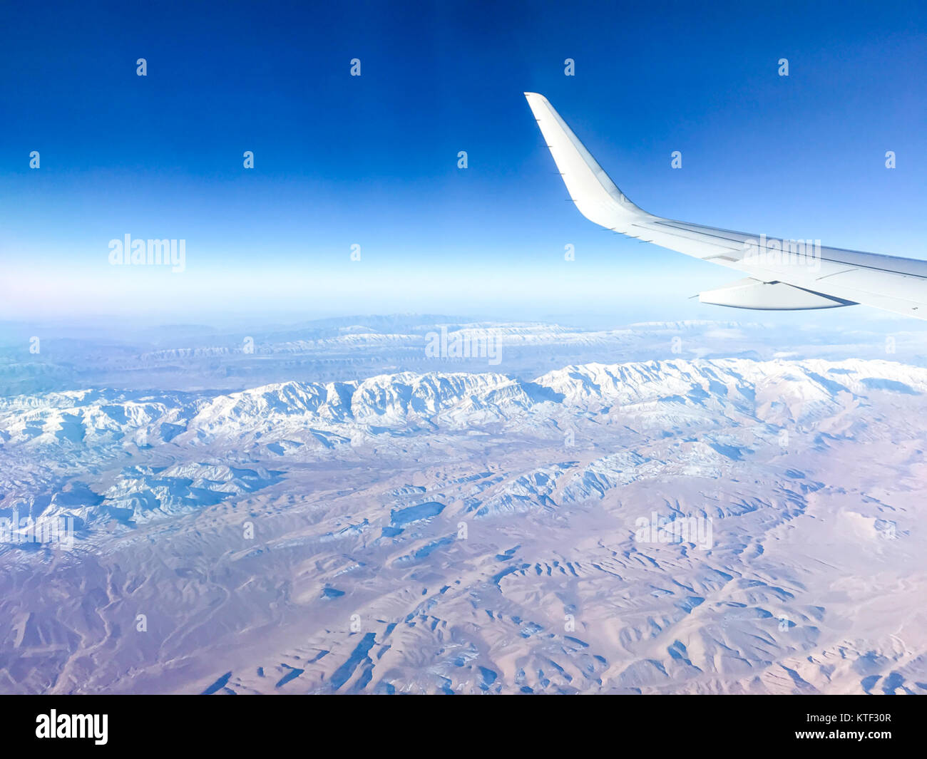 Mountains in the airplane window. Studio Photo Stock Photo - Alamy
