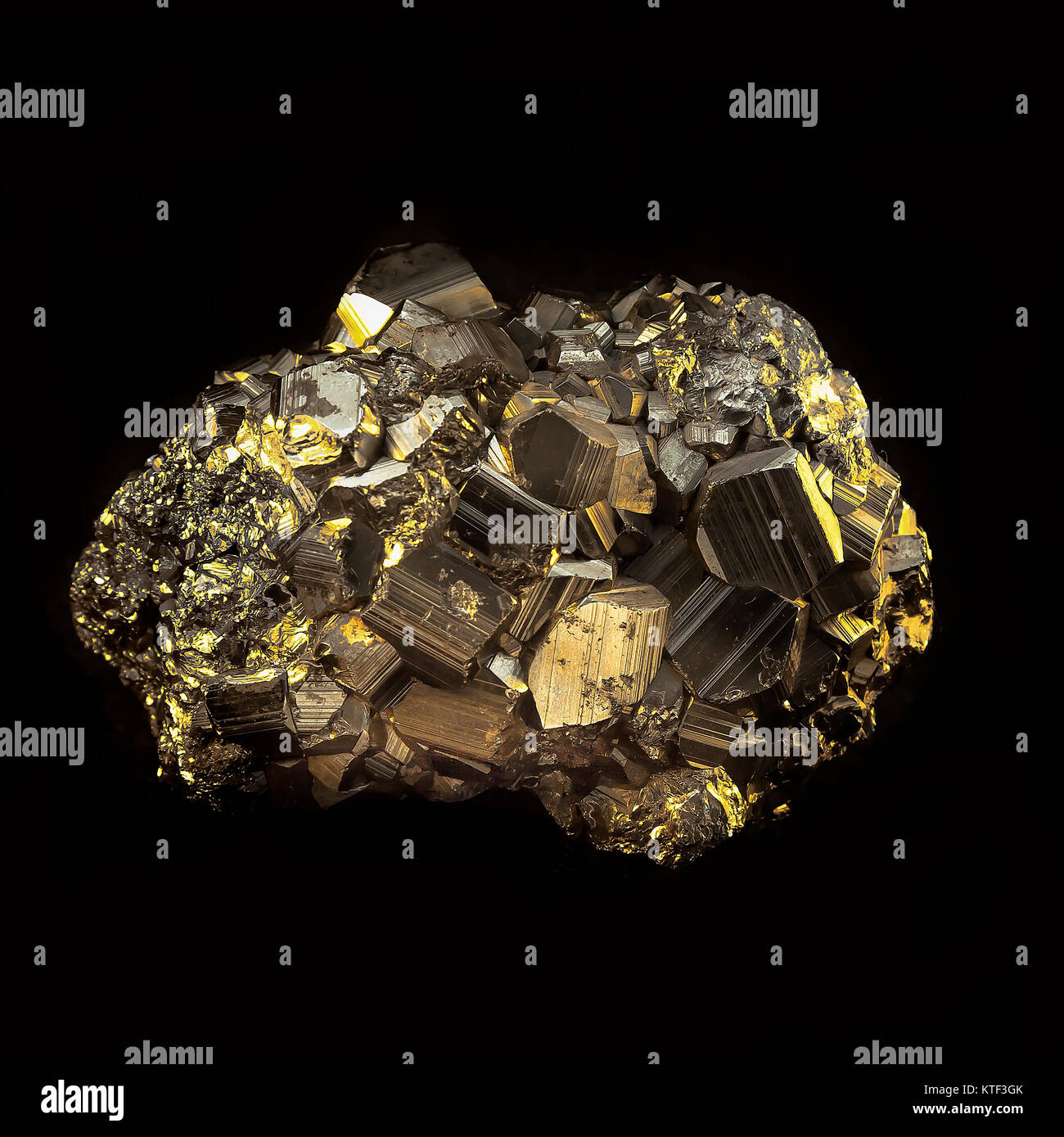 Pyrite Stone. Golden natural raw gemstone Isolated. close up i a black ...