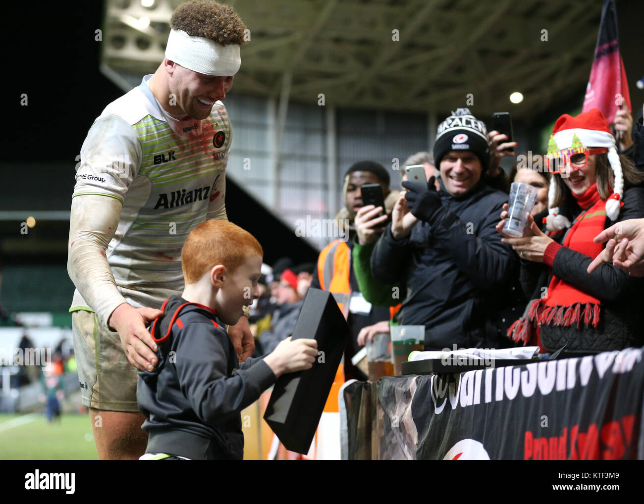 A young fan receives a Christmas present from Saracens' Nick Isiekwe ...