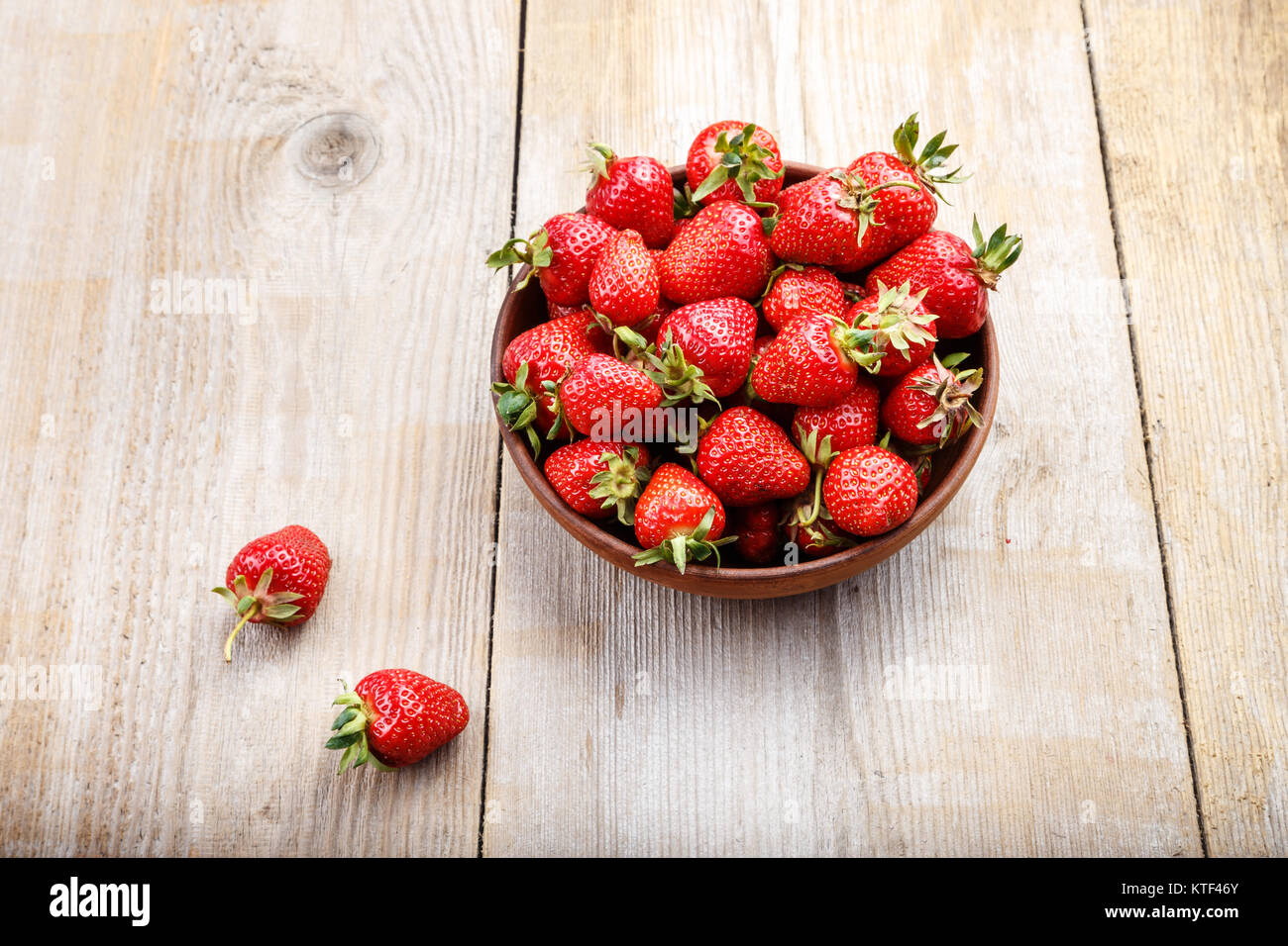 Fresh strawberry in a clay plate on wooden table , top view Stock Photo ...