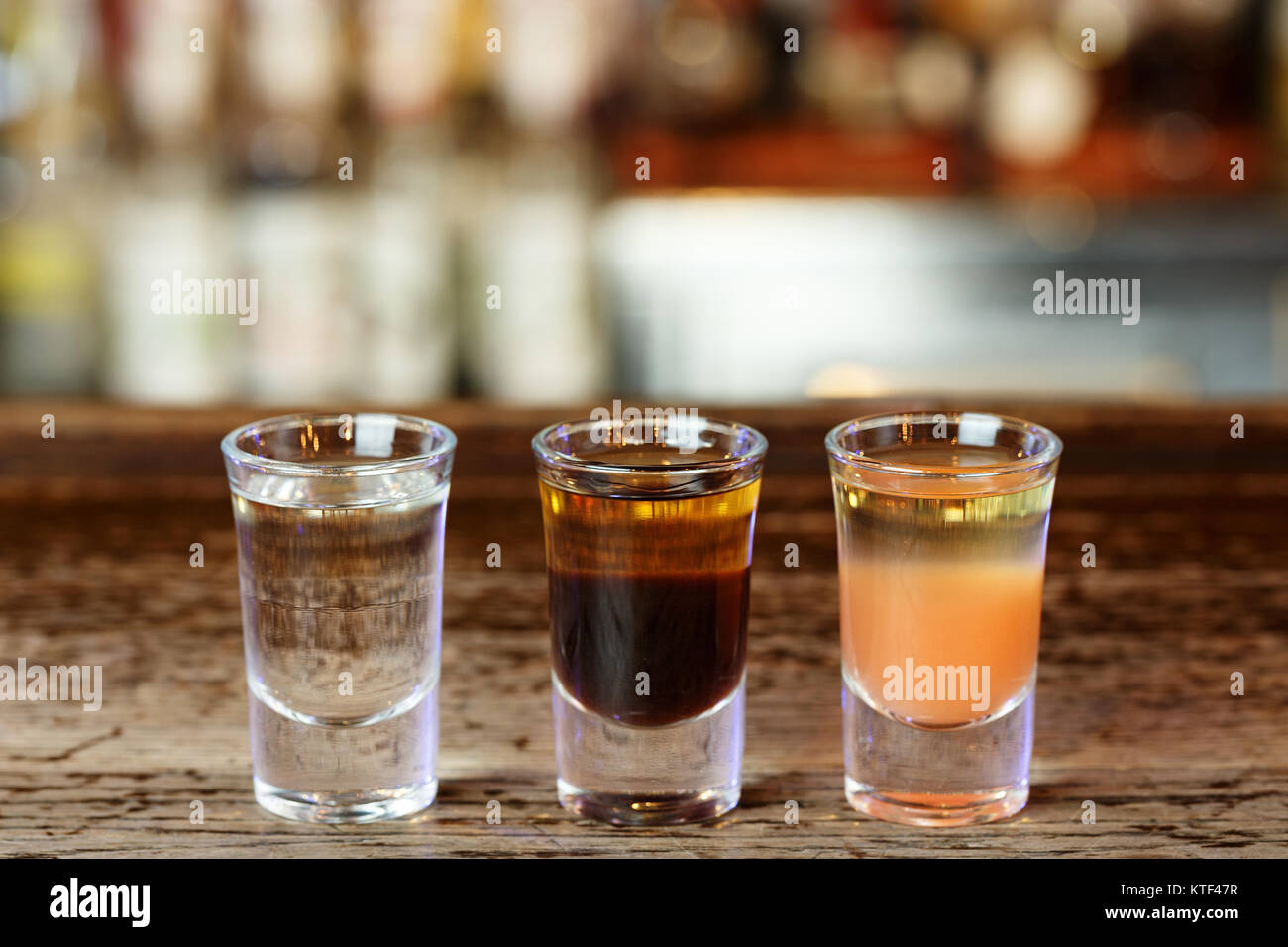 Different strong alcoholic cocktails shots in a nightclub on the bar ...