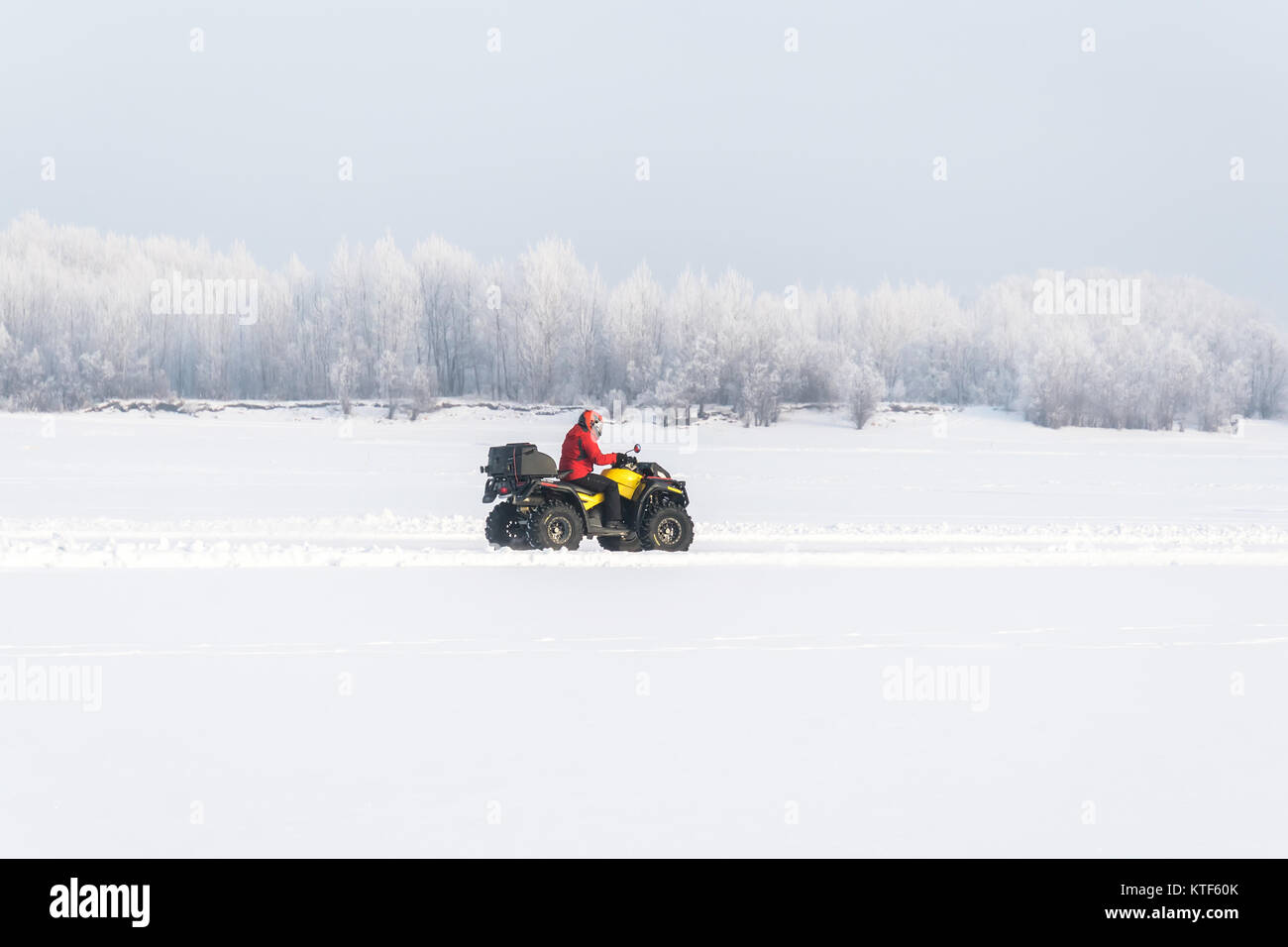 ATV driving on a snowy highway. Winter event on the Quad. extreme ...