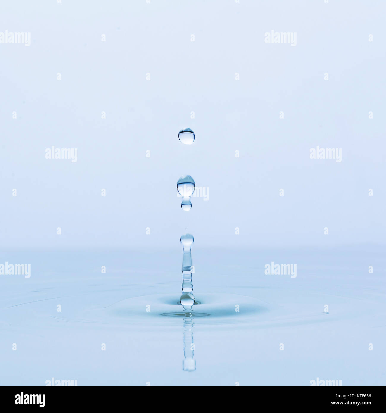 Blue water drop falling down Stock Photo - Alamy