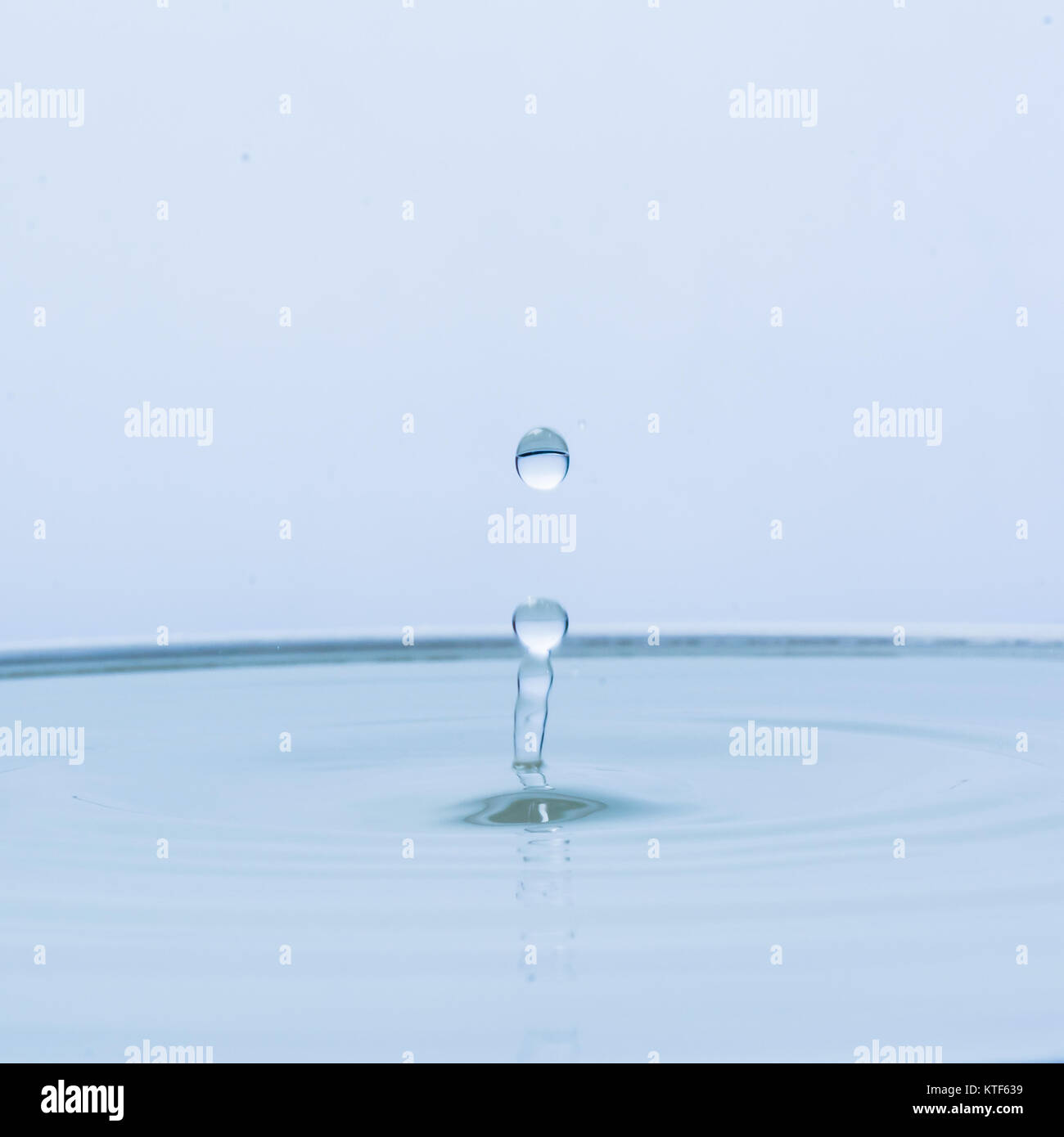 Blue water drop falling down Stock Photo - Alamy