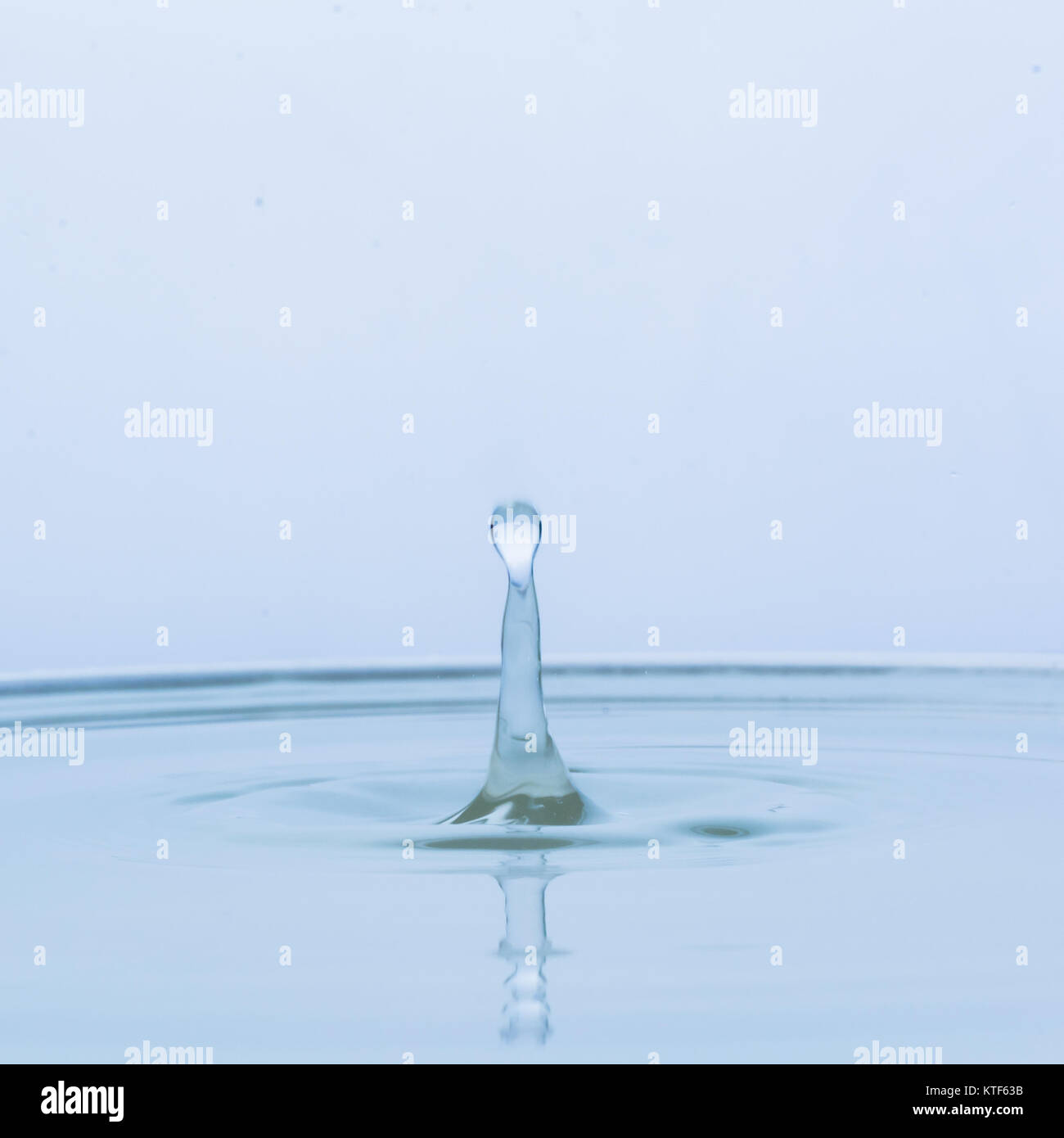 Blue water drop falling down Stock Photo - Alamy