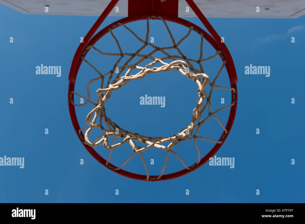 Closeup basketball hoop, basket with white net and blue sky in ...