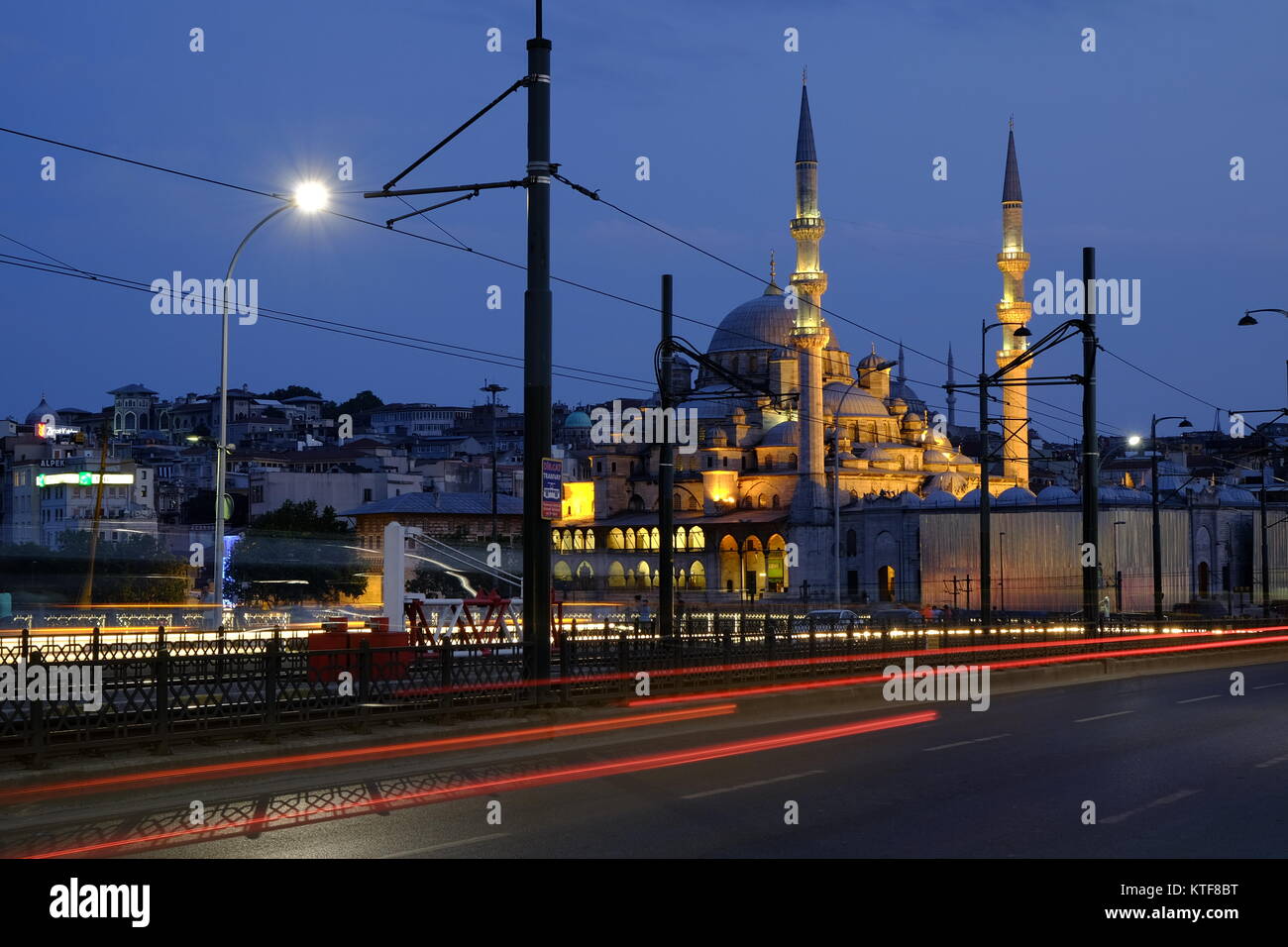 Yeni Cami, the New Mosque at night with the lights of the traffic in ...