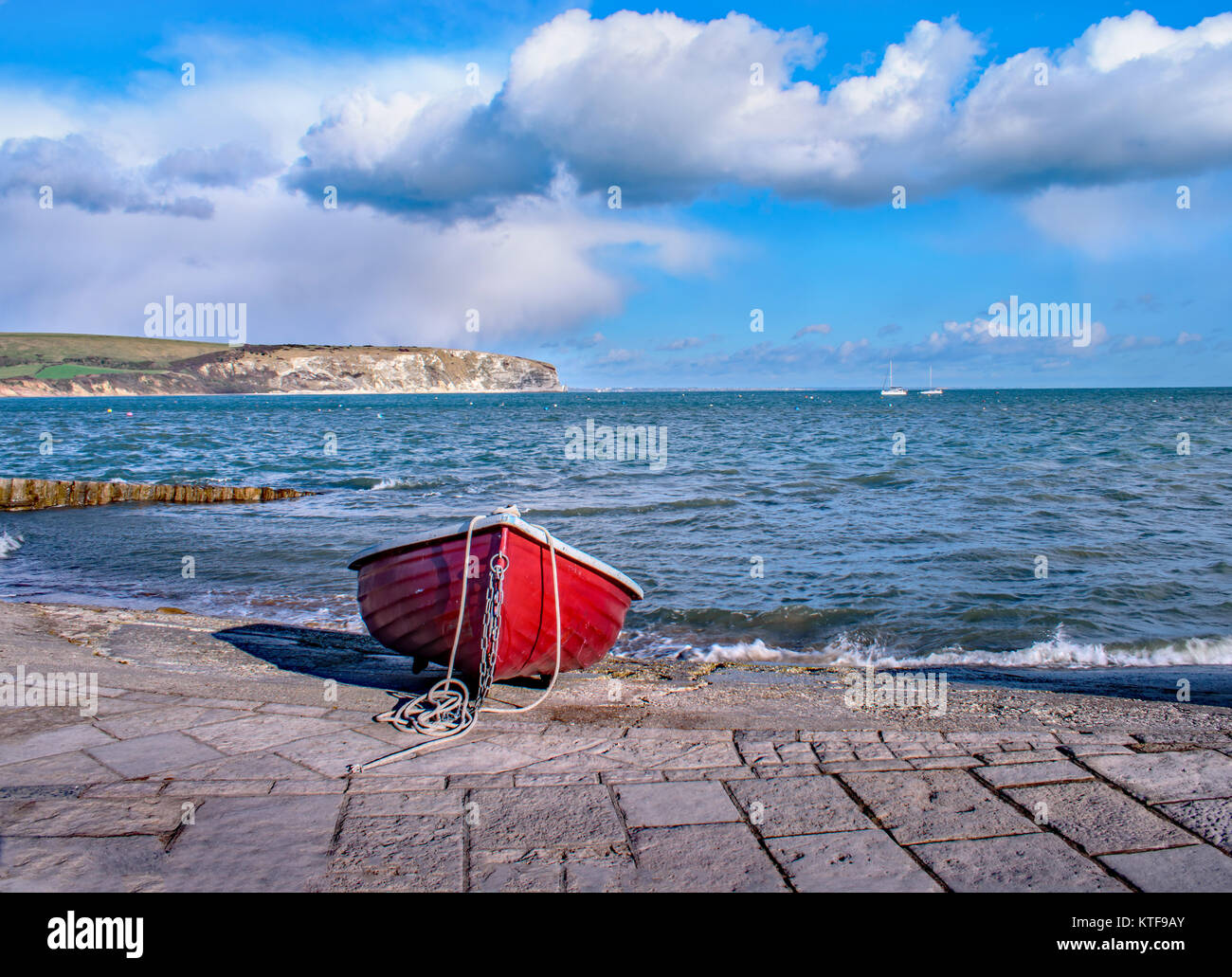 A Bright Red Rowboat on the slipway at Swanage Beach Stock Photo - Alamy