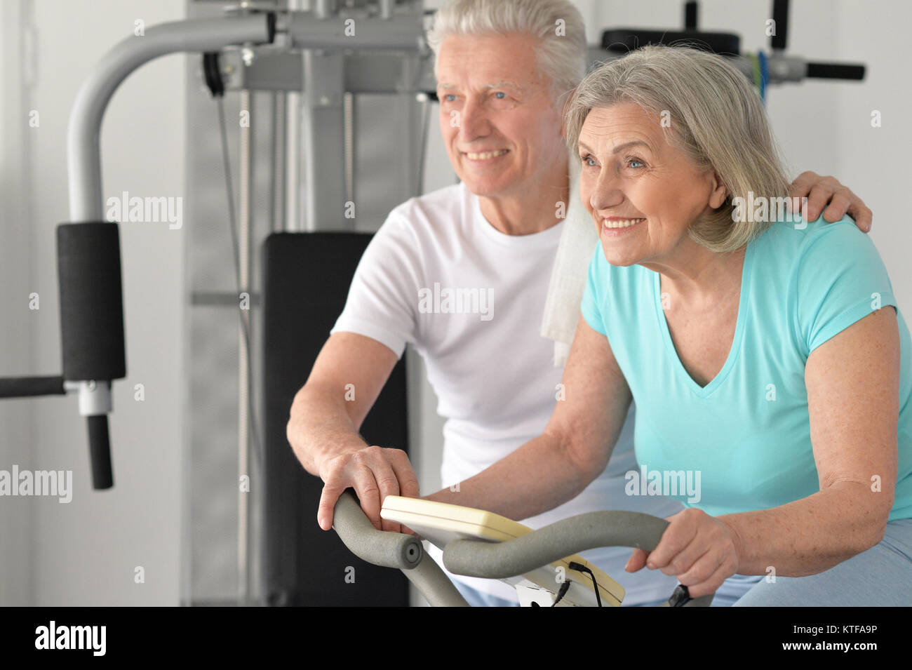 Active smiling senior couple exercising in gym Stock Photo - Alamy