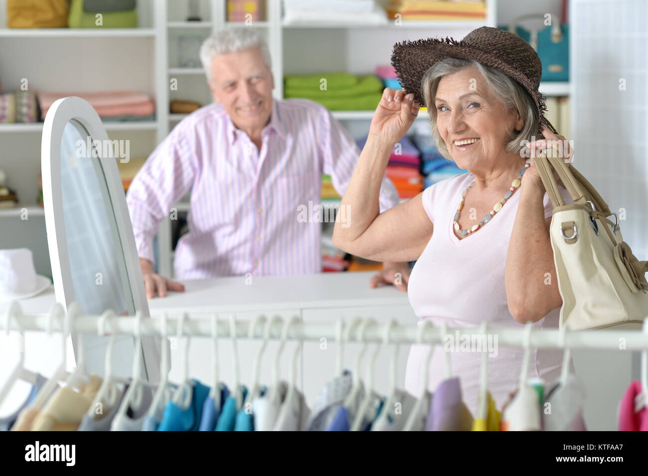 Portrait of senior couple choosing hat in shop Stock Photo - Alamy