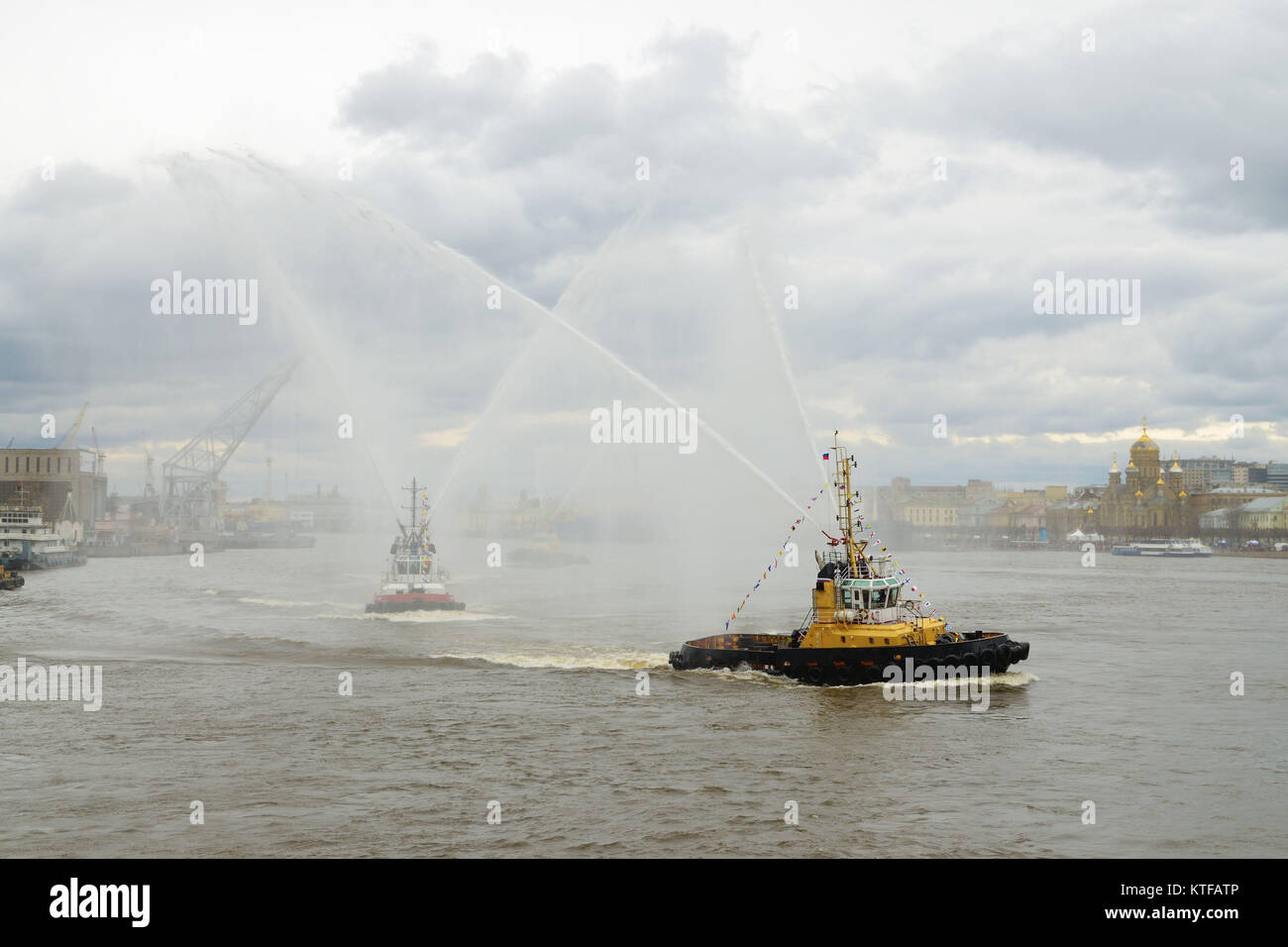 Marine boat tug boat floats on the river and throws up water fountains ...