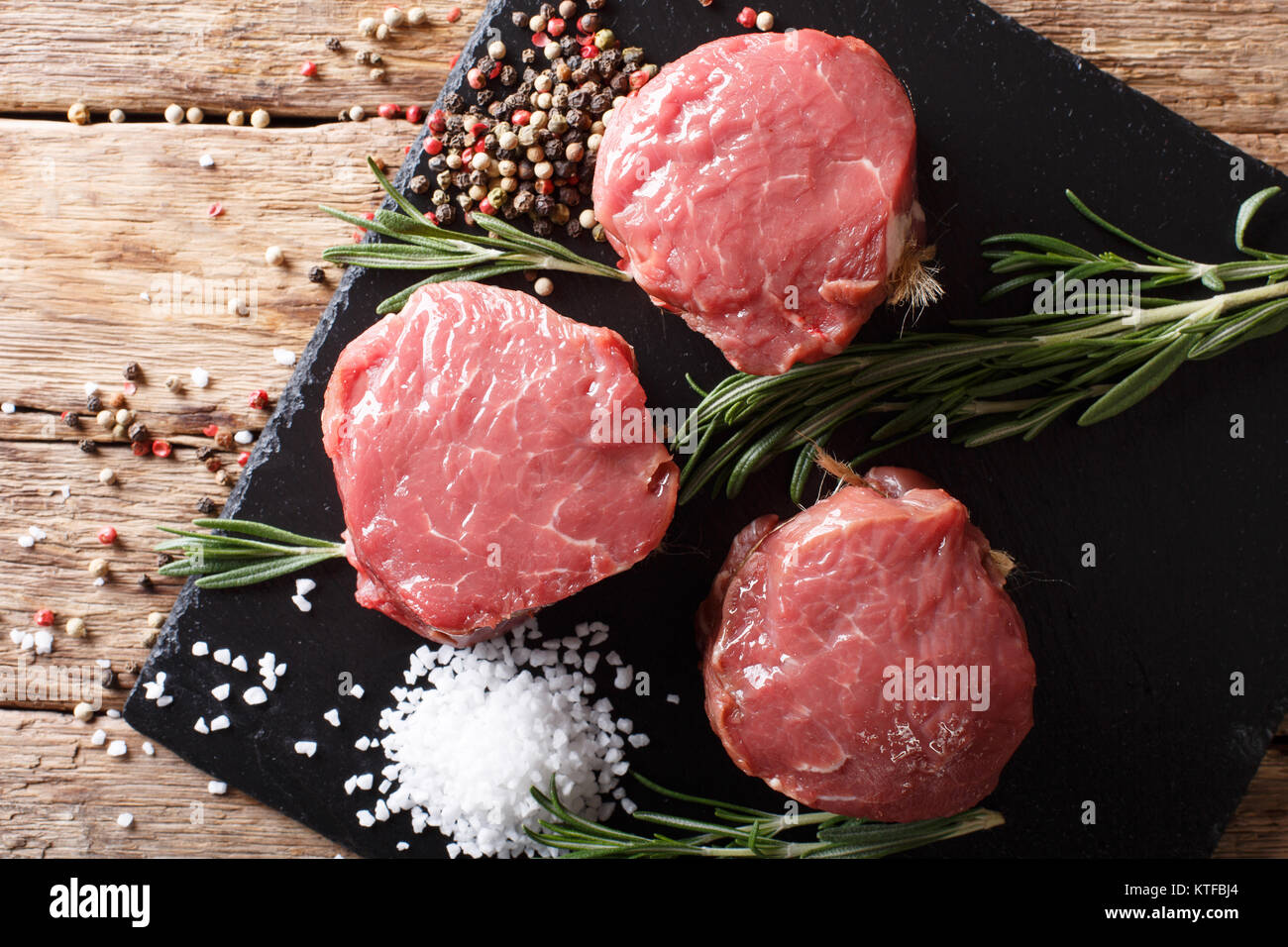 fresh raw beef filet mignon with spices cut ready to cook close up on ...