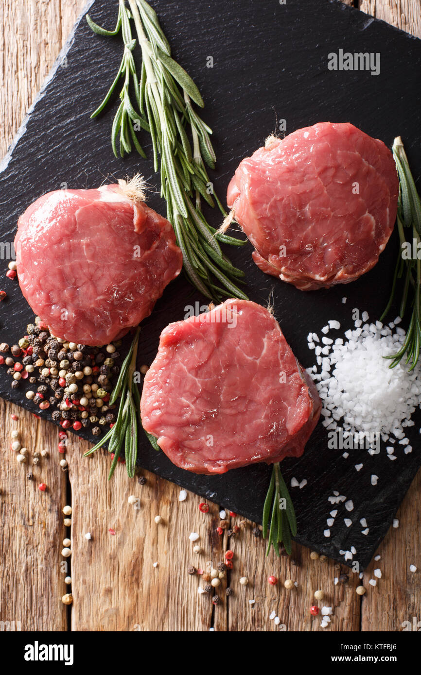 fresh raw beef filet mignon with spices cut ready to cook close up on ...