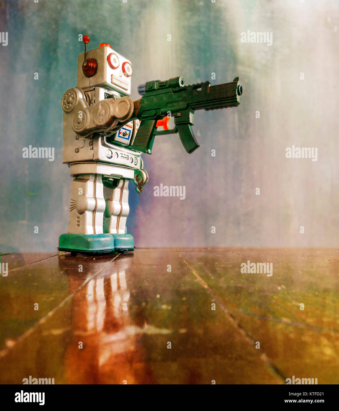 retro robot toy shoots a big gun on a wooden floor Stock Photo - Alamy