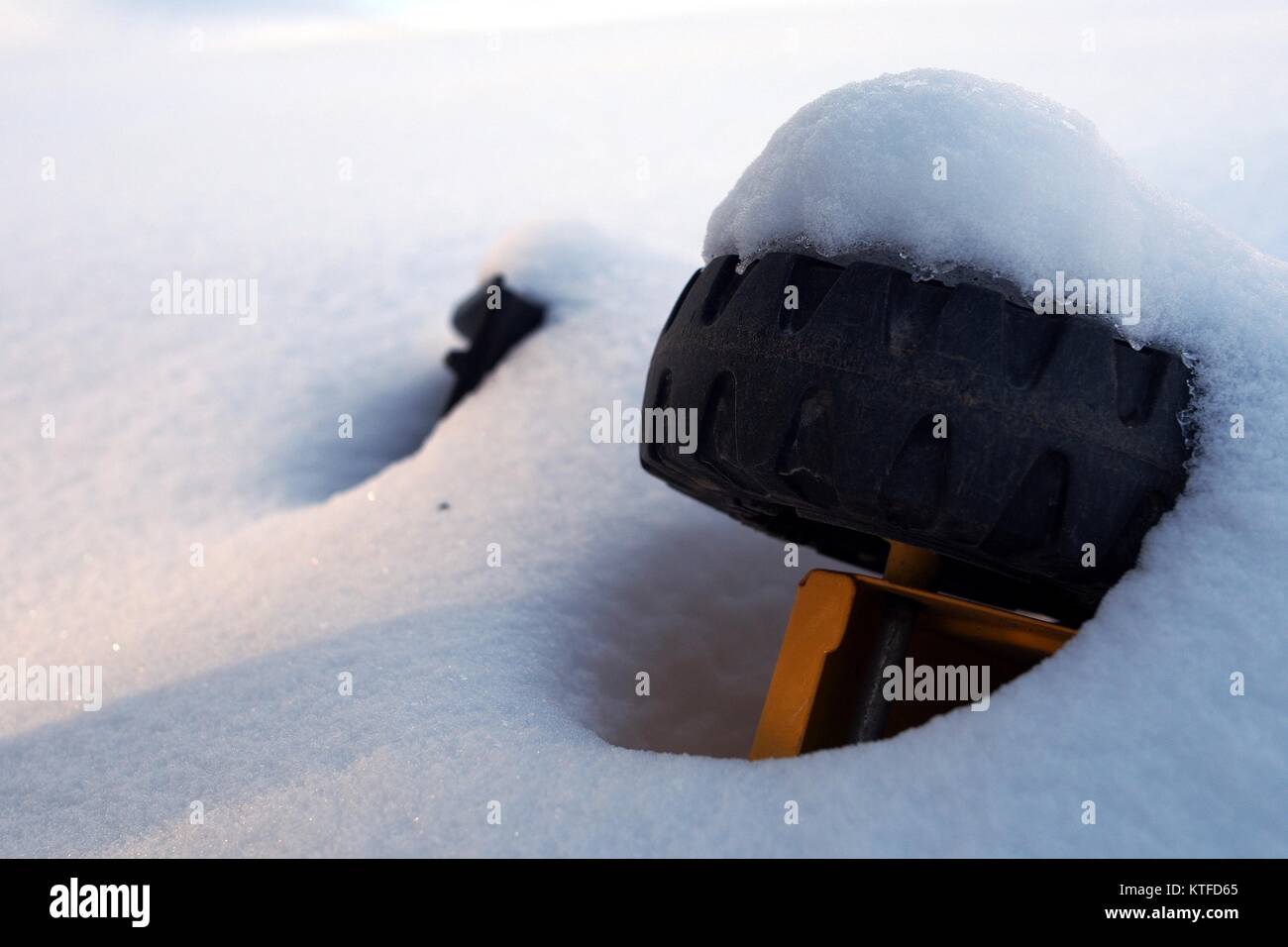 Metal toy truck wheel poking through the fresh snow in a Glebe park ...