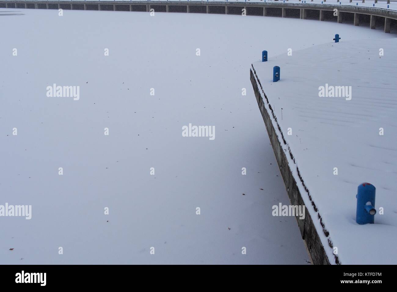 Snow covered boardwalk and blue mooring posts at the north end of Dow's ...