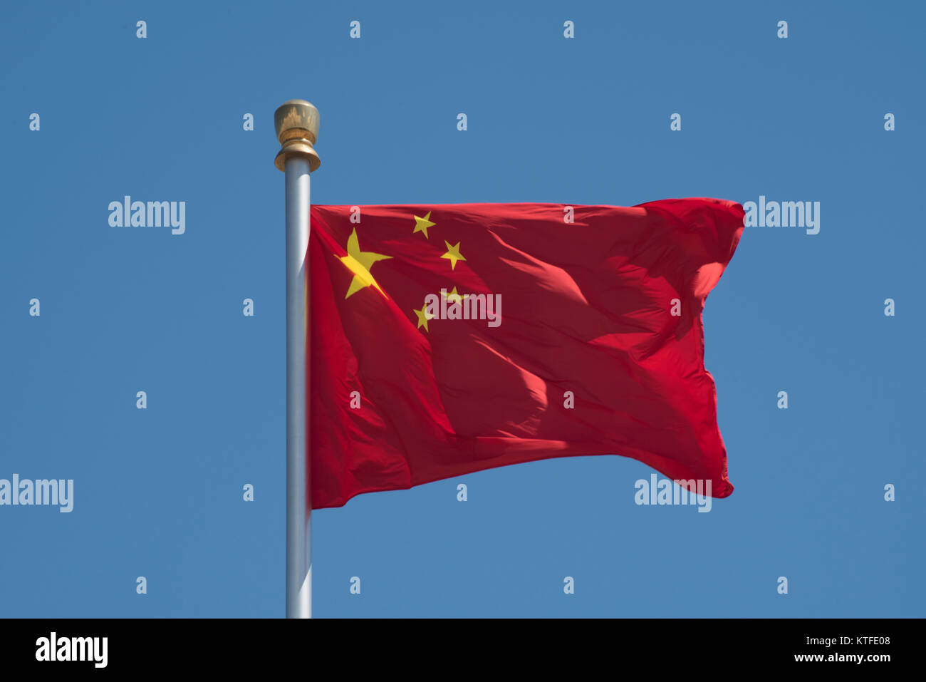 Flying Chinese National Flag against blue sky Stock Photo - Alamy