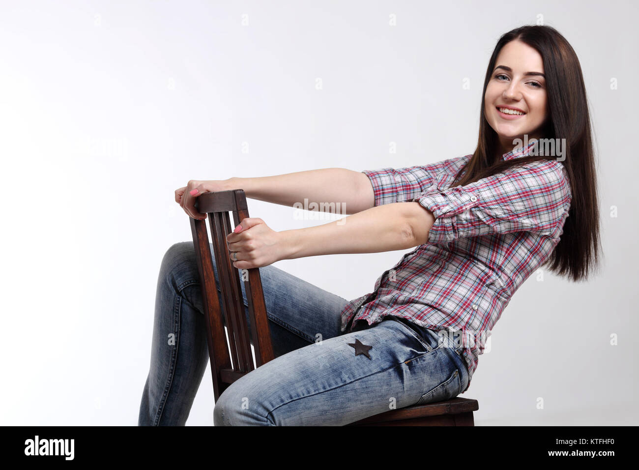 Nice girl sitting on chair hi-res stock photography and images - Alamy