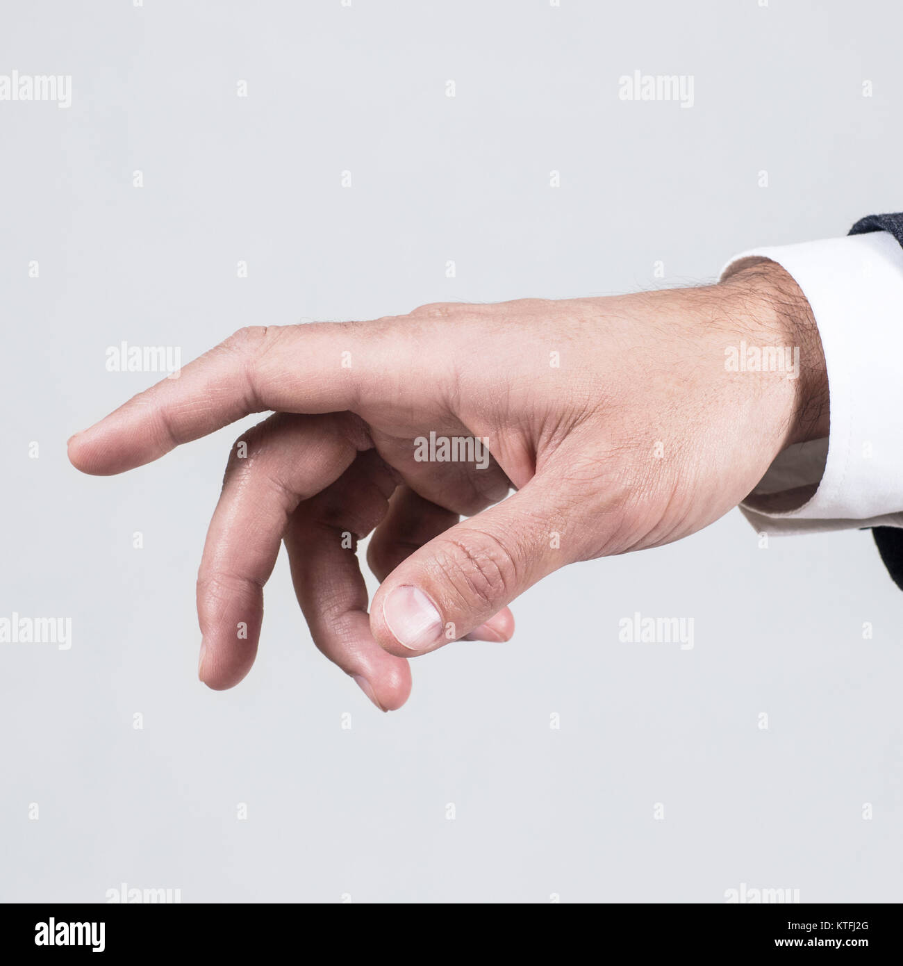 Businessman's hand pointing in the air. Over gray background Stock ...