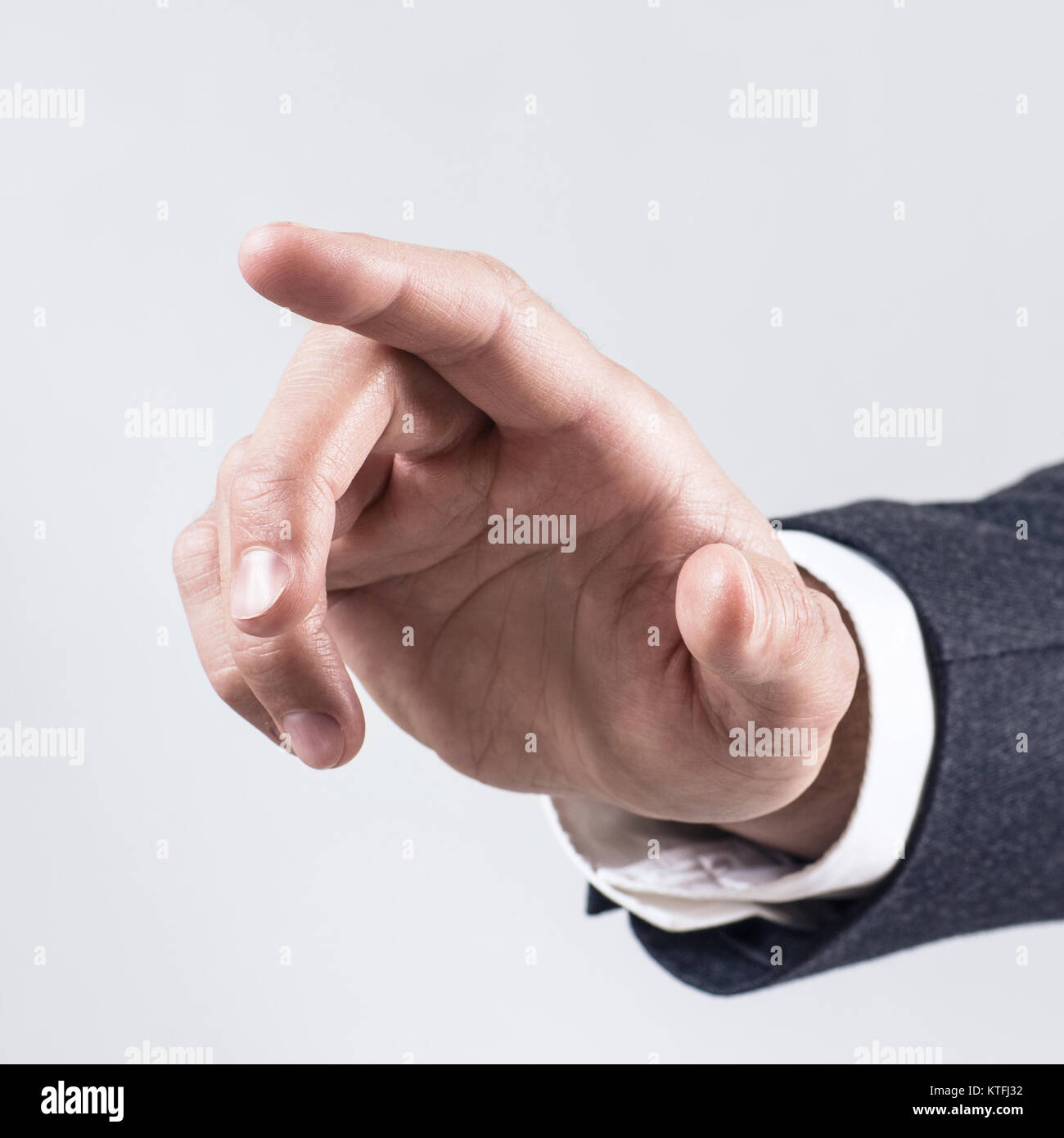 Businessman's hand pointing in the air. Over gray background Stock ...