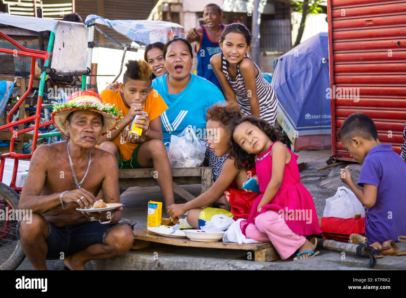 Cebu City, Philippines. 25th Dec, 2017. Homeless people sitting on the ...