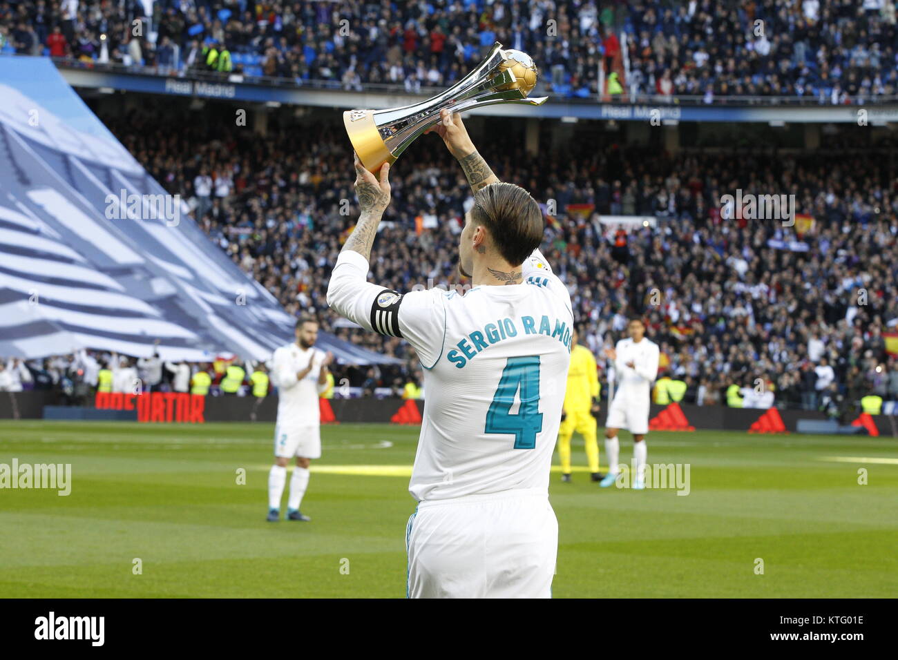 Soccer player Sergio Ramos teaches the public the trophy of the club ...