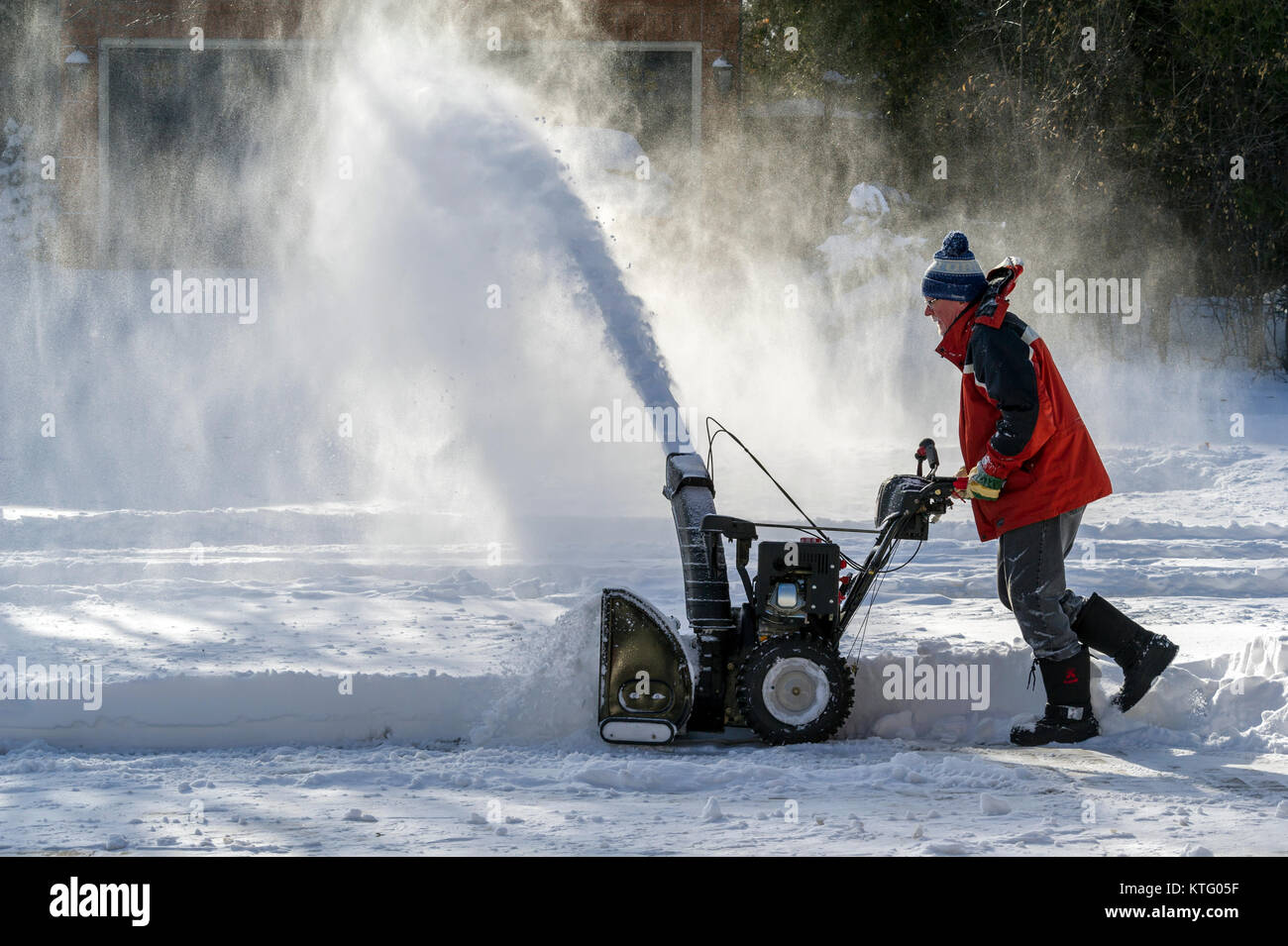 Oakville, Ontario, Canada December 25, 2017. Man with a snowblower ...