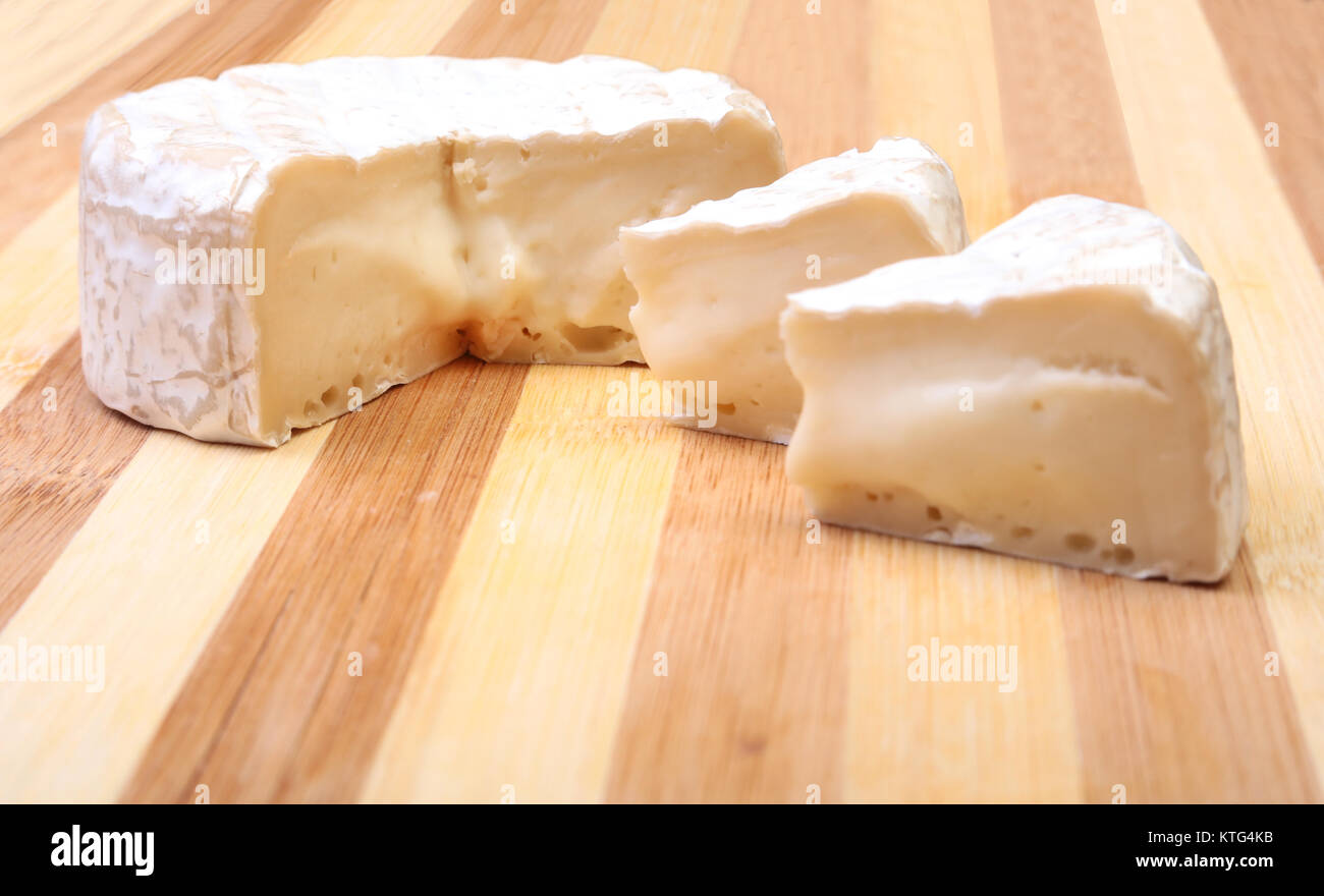 Cheese with white mold. Camembert or brie type on wood table. Healthy ...