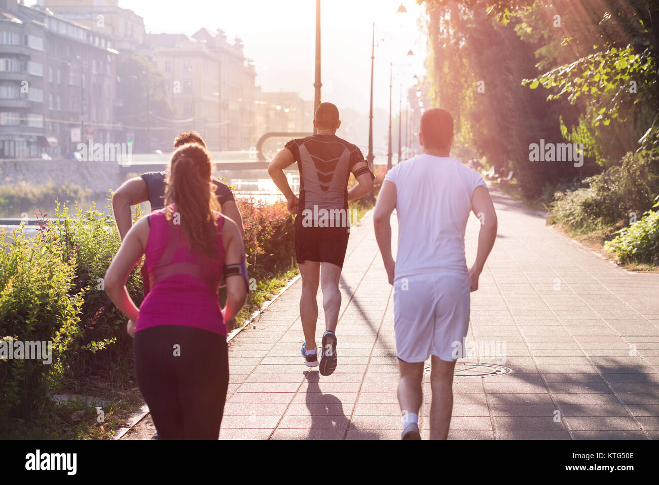 group of young sporty people jogging at sunny morning in the city Stock ...