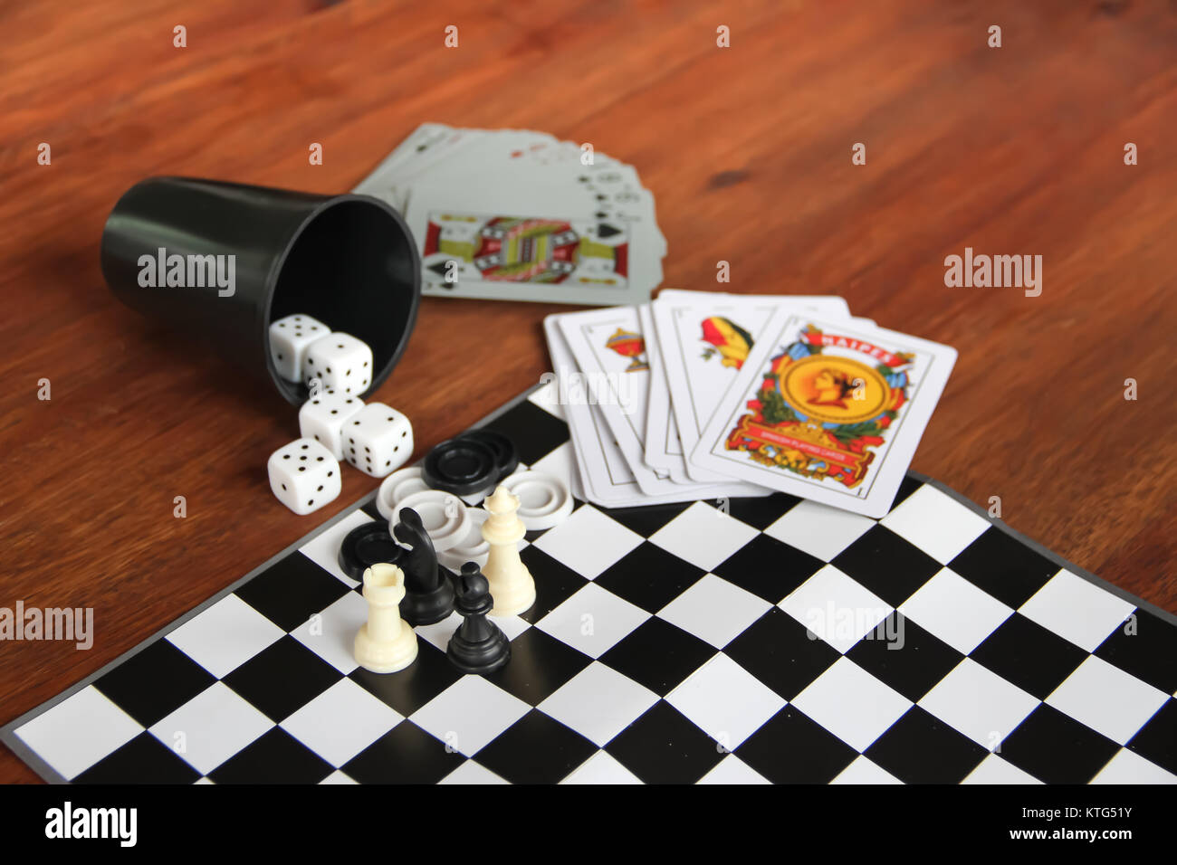 mix of goblet table games dice spanish poker cards chess and checkers ...