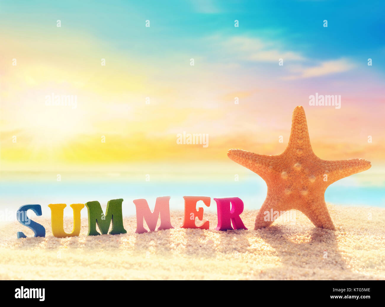 Summer beach. Letters and starfish on a beach sand against the ...