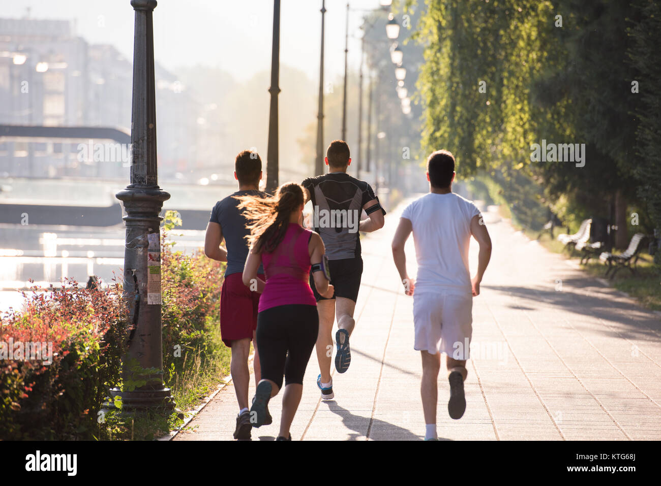 group of young sporty people jogging at sunny morning in the city Stock ...