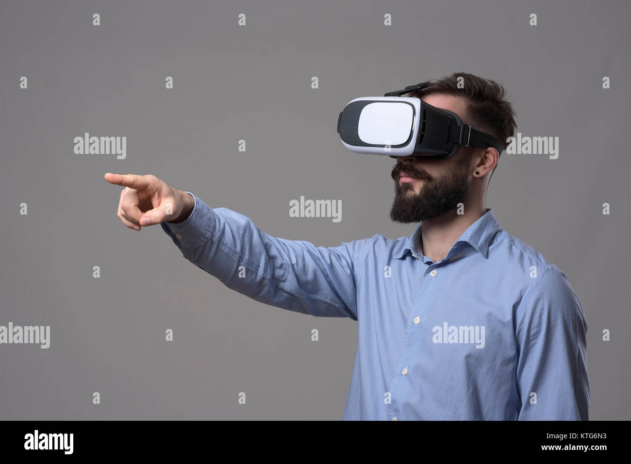 Side view of business man wearing vr glasses outstretching hand and ...